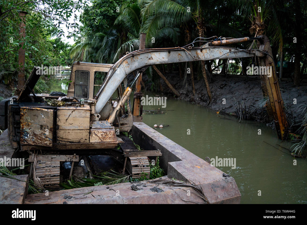 Excavator digger machine at canal construction site hi-res stock ...
