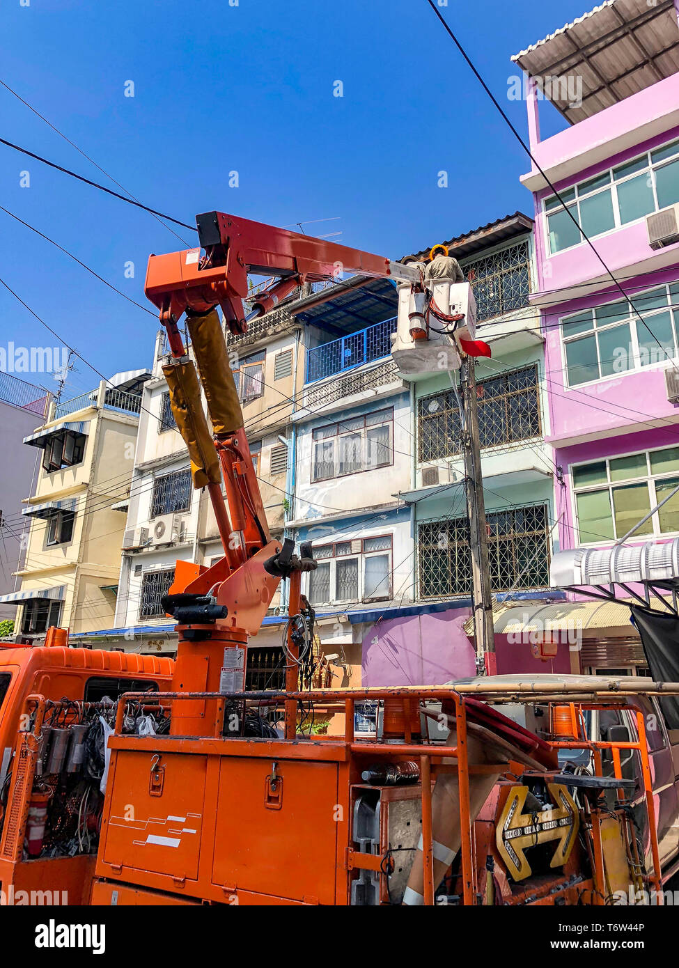 Electrician on the truck crane shifted up to check and repair main ...