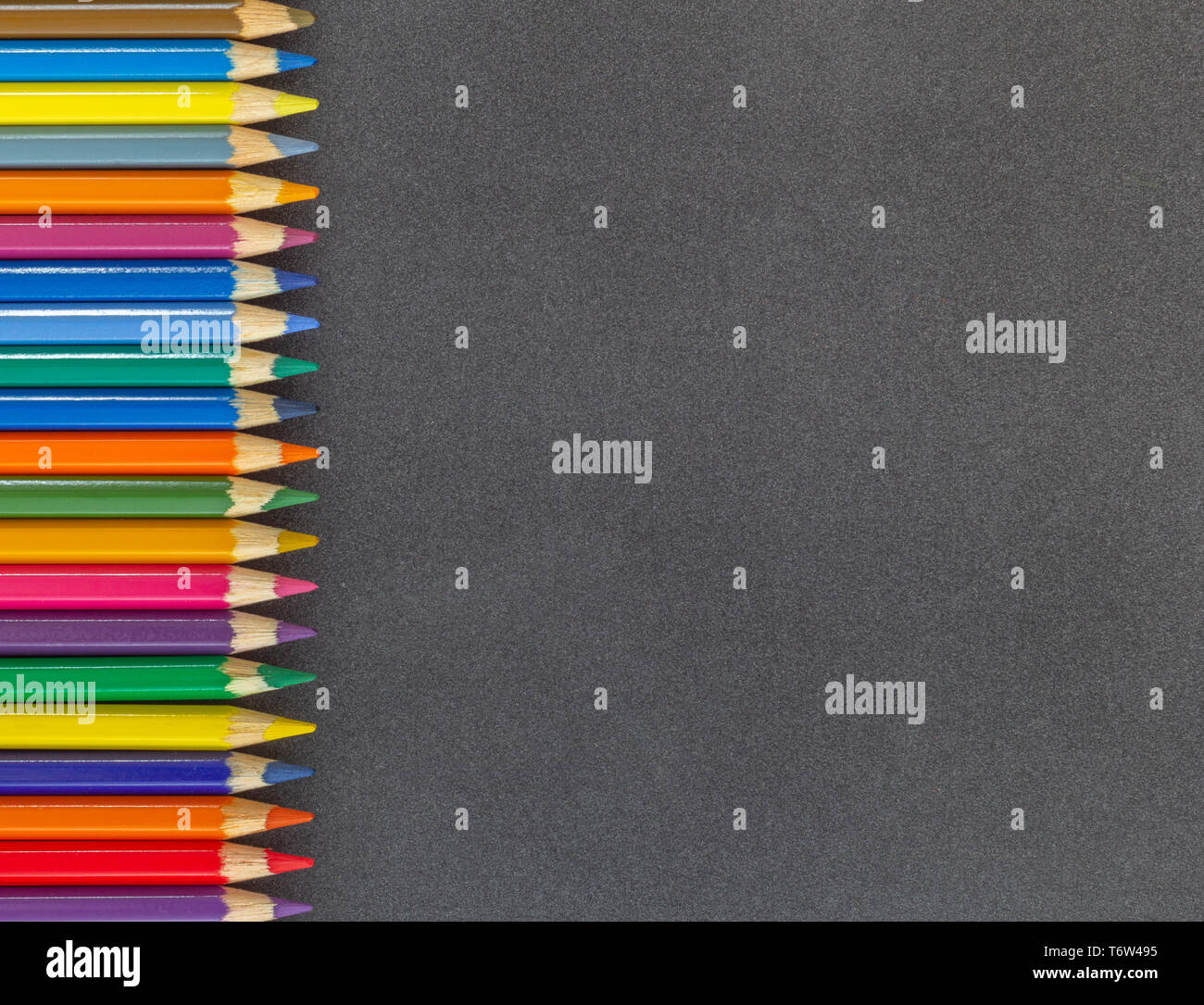 Line of colored pencils left side dark background top view Stock Photo ...