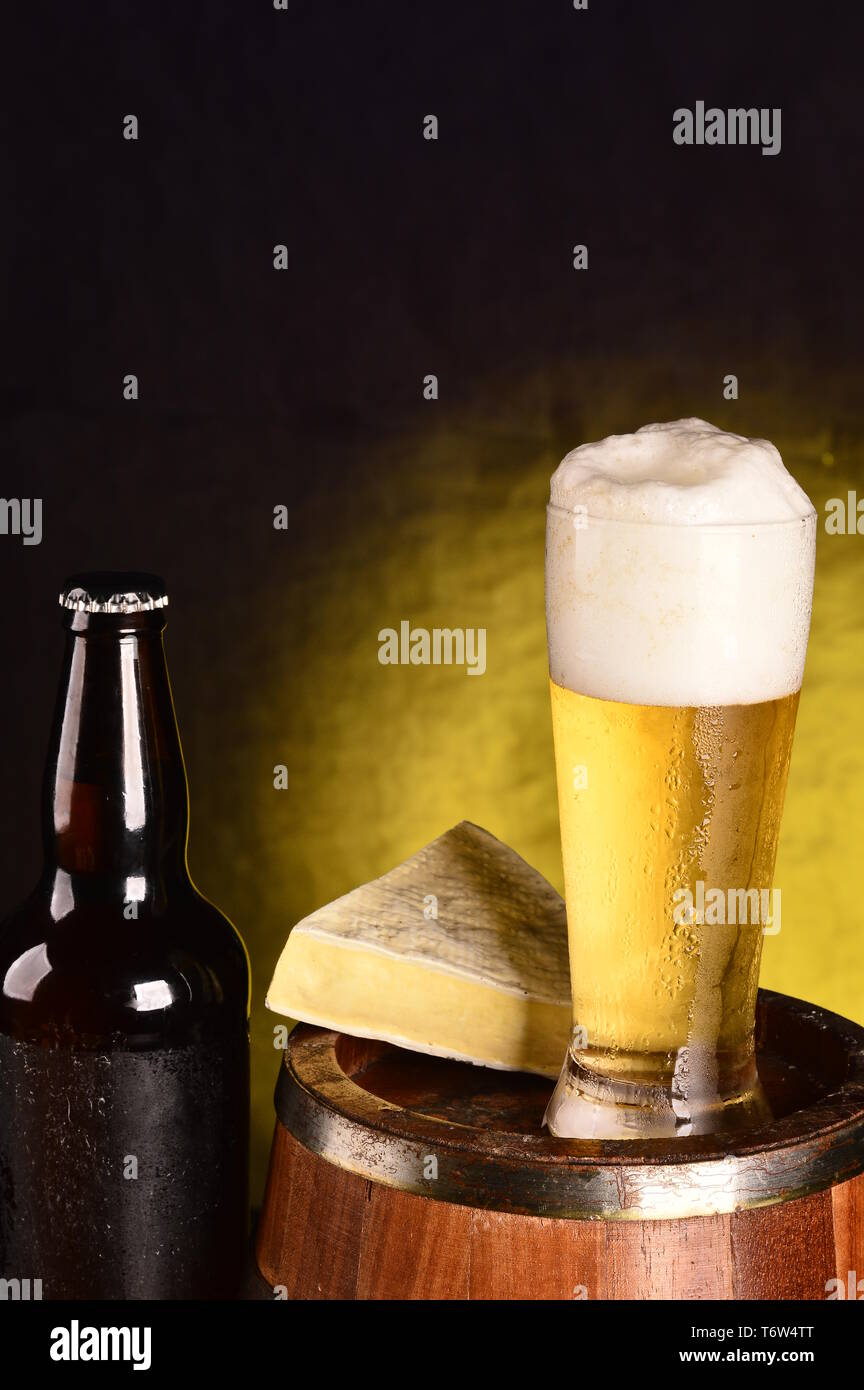 Glass of beer in yellow background Stock Photo - Alamy