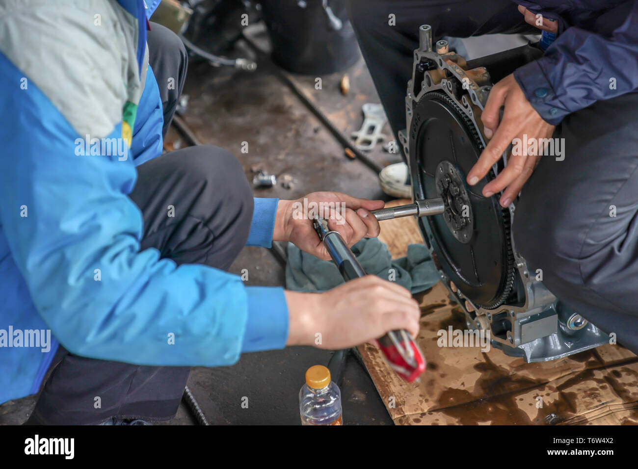 2 mechanic men try to fix and setup boat engine Stock Photo - Alamy
