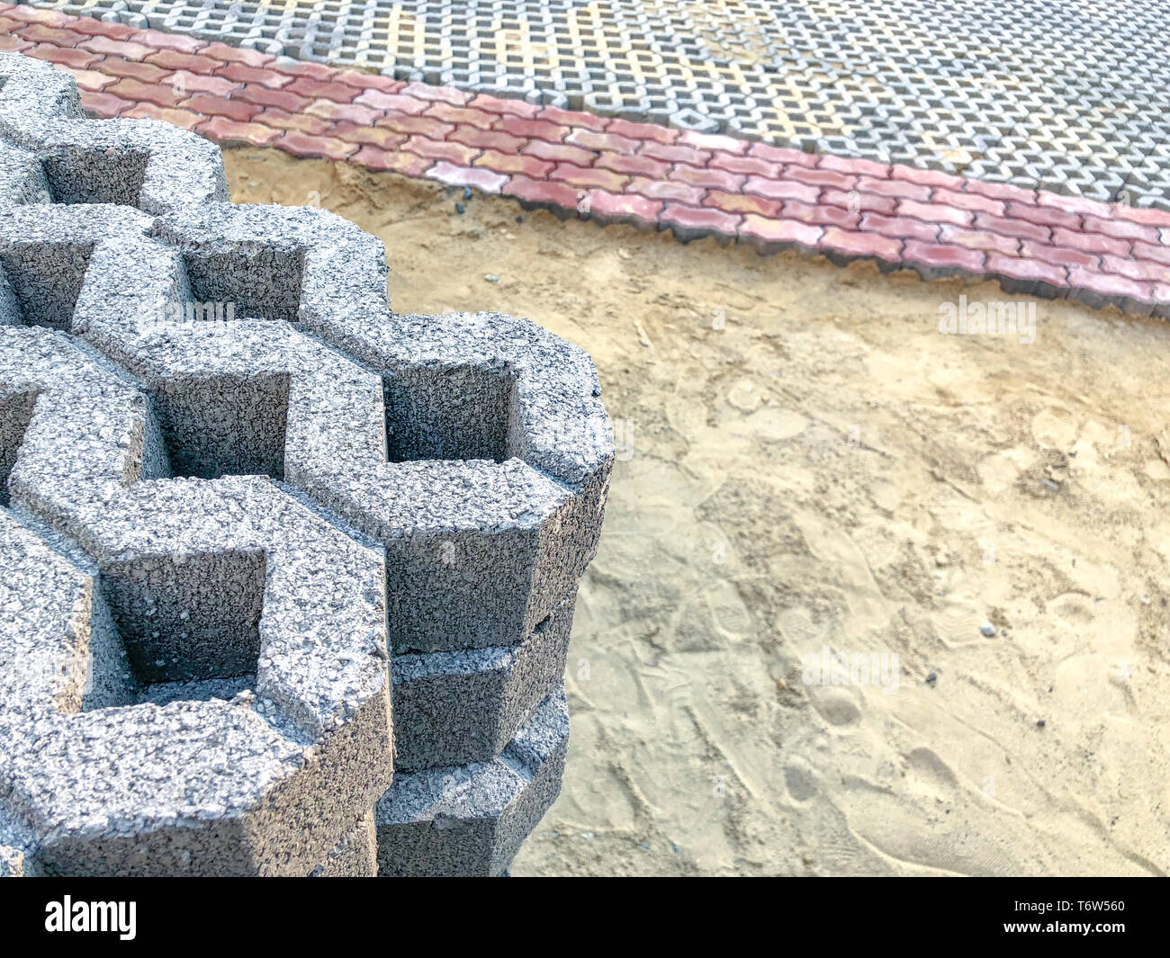 gray color stone brick block floor tile with green grass and sand as ...