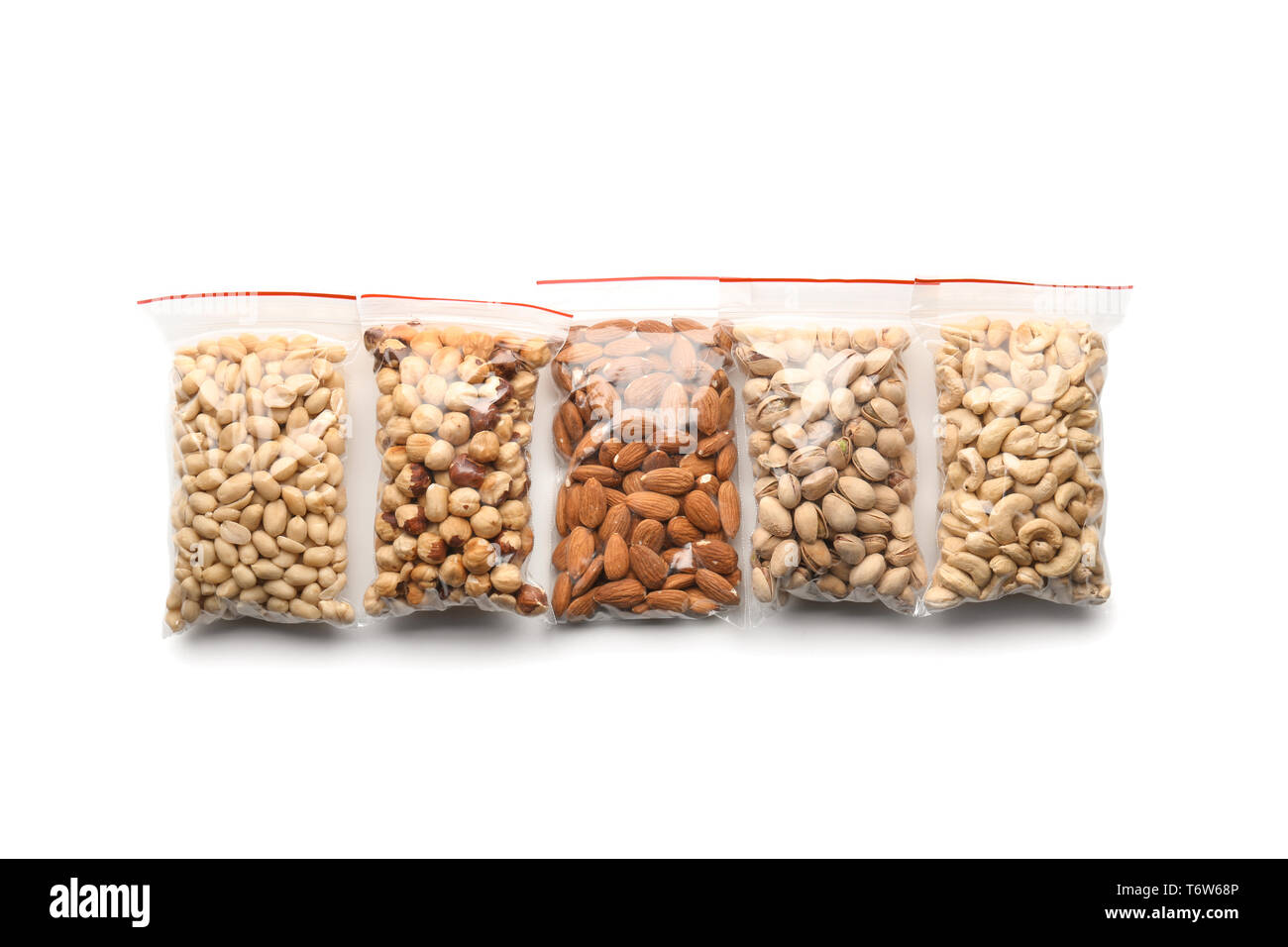 Different types of nuts in packages on white background Stock Photo - Alamy