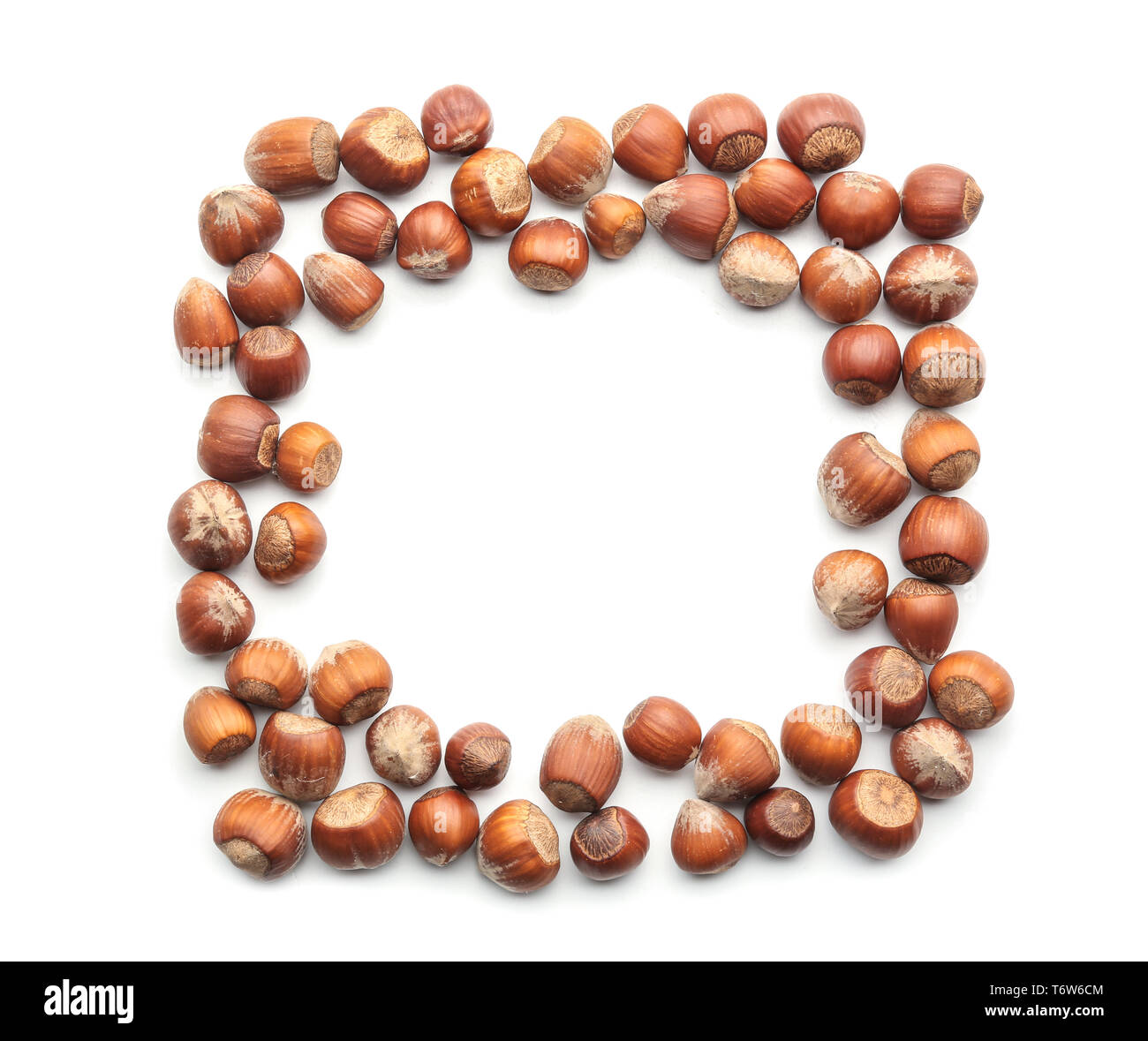Frame made of tasty hazelnuts on white background Stock Photo - Alamy