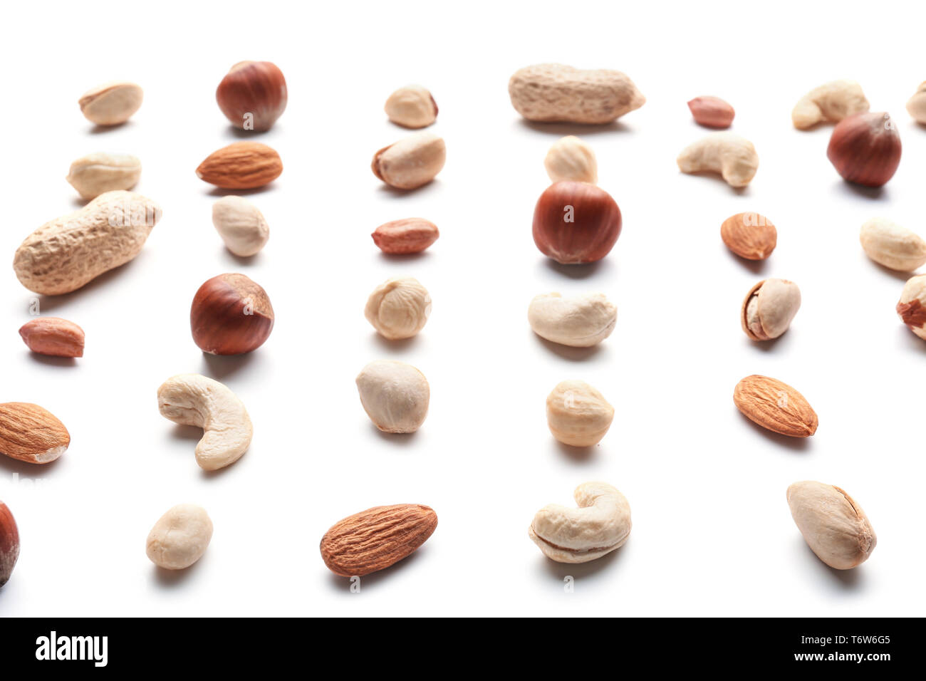 Different types of nuts on white background Stock Photo - Alamy