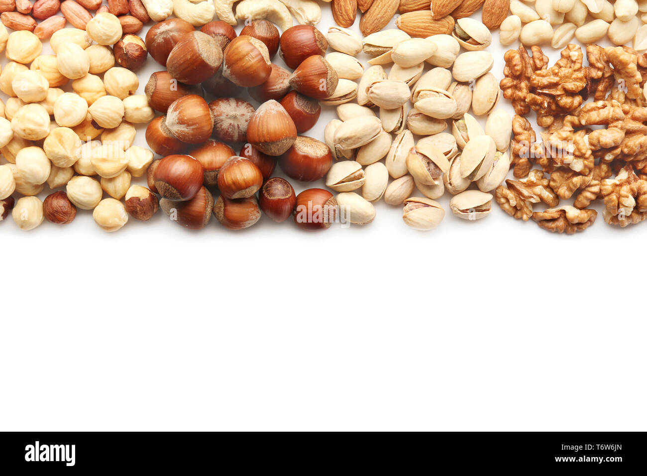 Different types of nuts on white background Stock Photo - Alamy