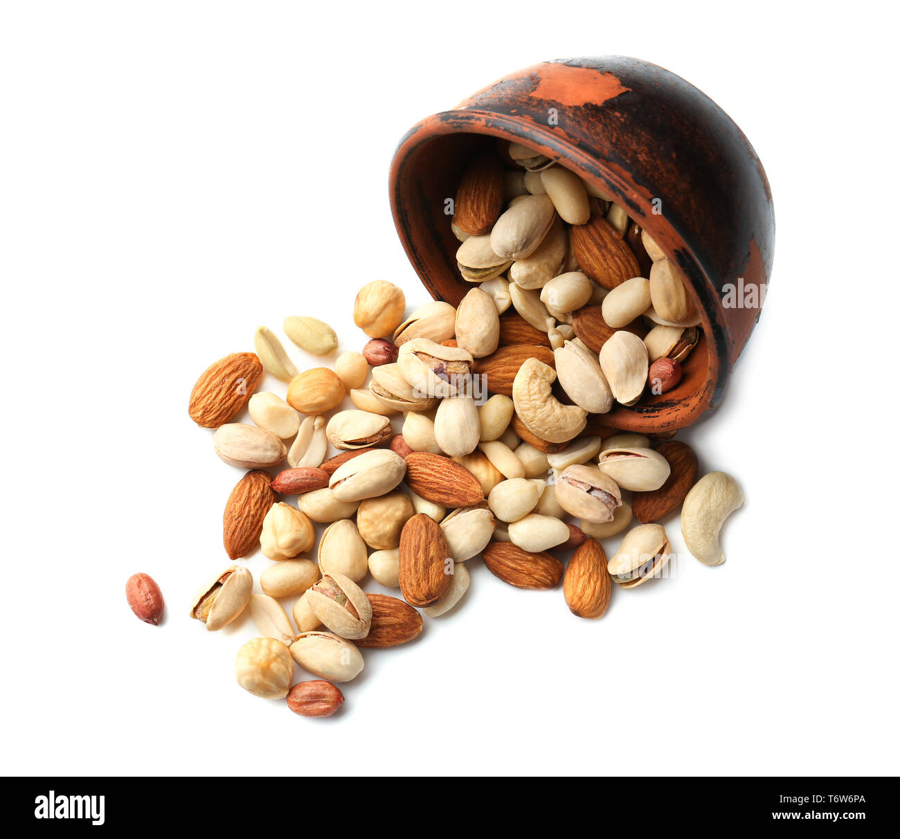 Overturned bowl with scattered nuts on white background Stock Photo - Alamy