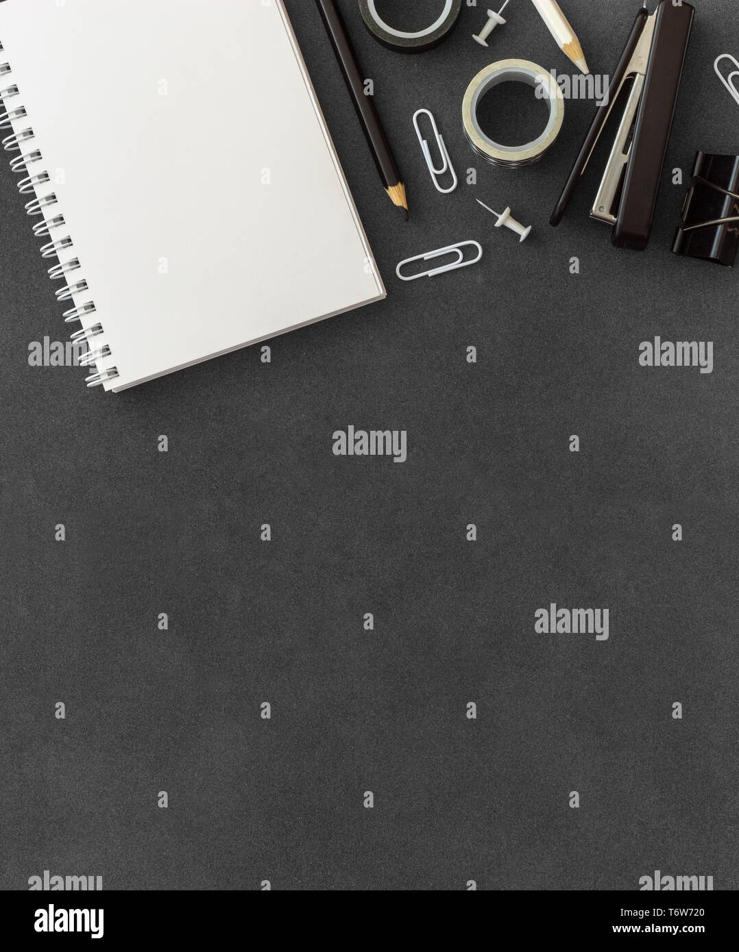 Blank white spiral paper notebook with stapler, paper clump, paper ...