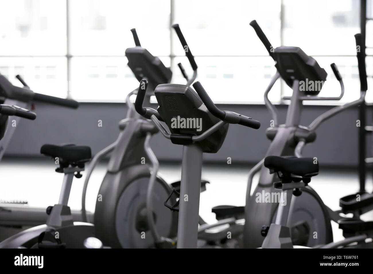 Modern exercise bicycles in gym Stock Photo - Alamy