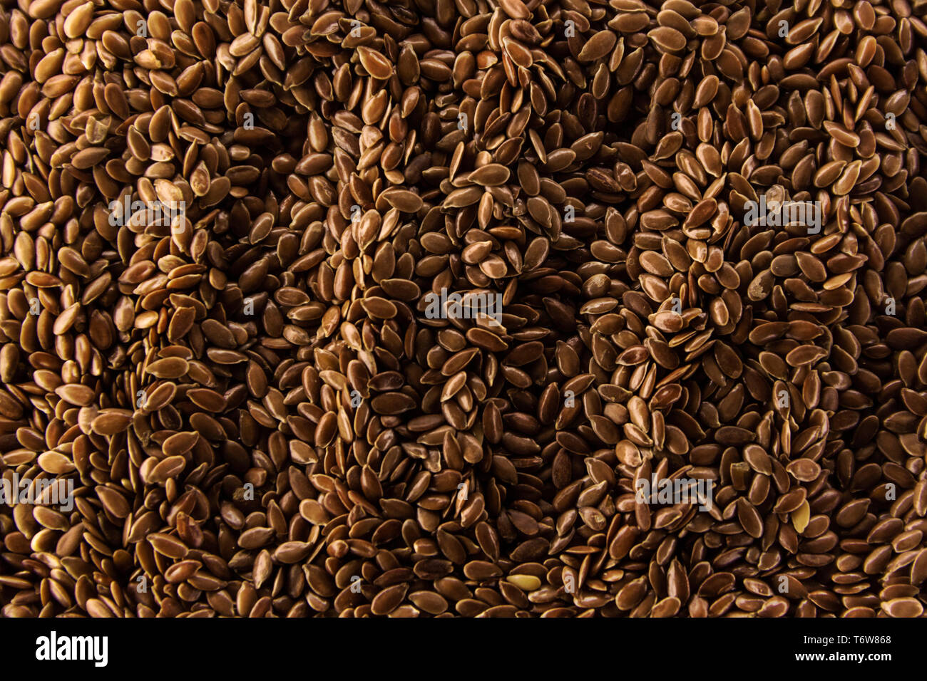 Brown flax seeds give flaxseed oil background Stock Photo - Alamy
