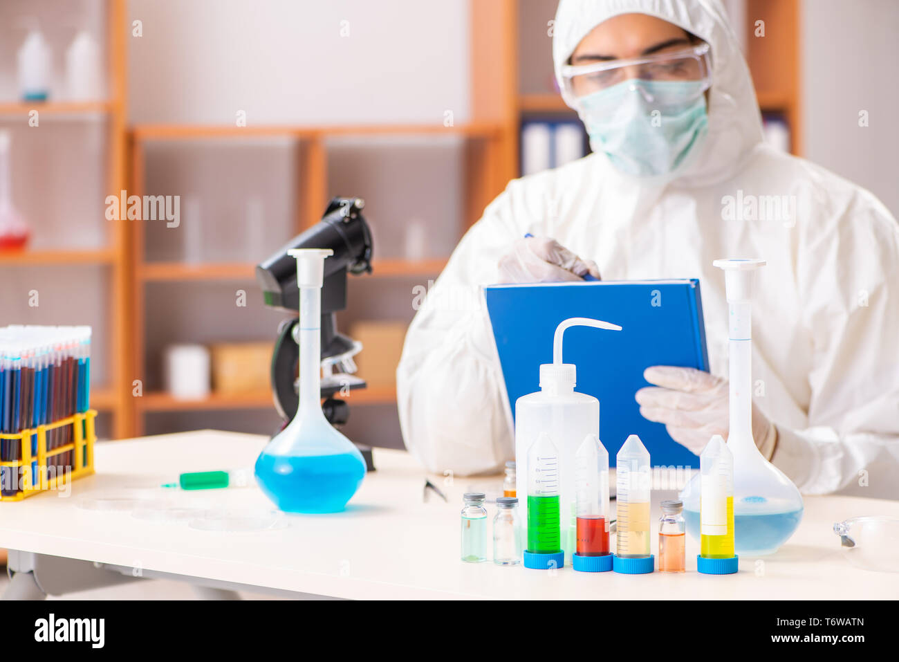 Young biochemist wearing protective suit working in the lab Stock Photo ...
