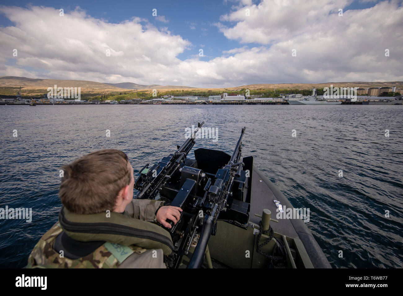 Embargoed to 0001 Friday May 3 A Royal Marine patrols the waters at ...