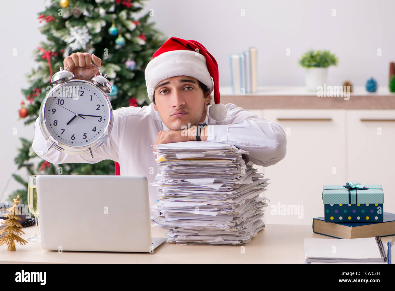 Young worker working in office on christmas shift Stock Photo - Alamy