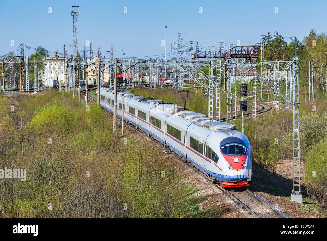 Modern high-speed train moves through the station at spring morning ...