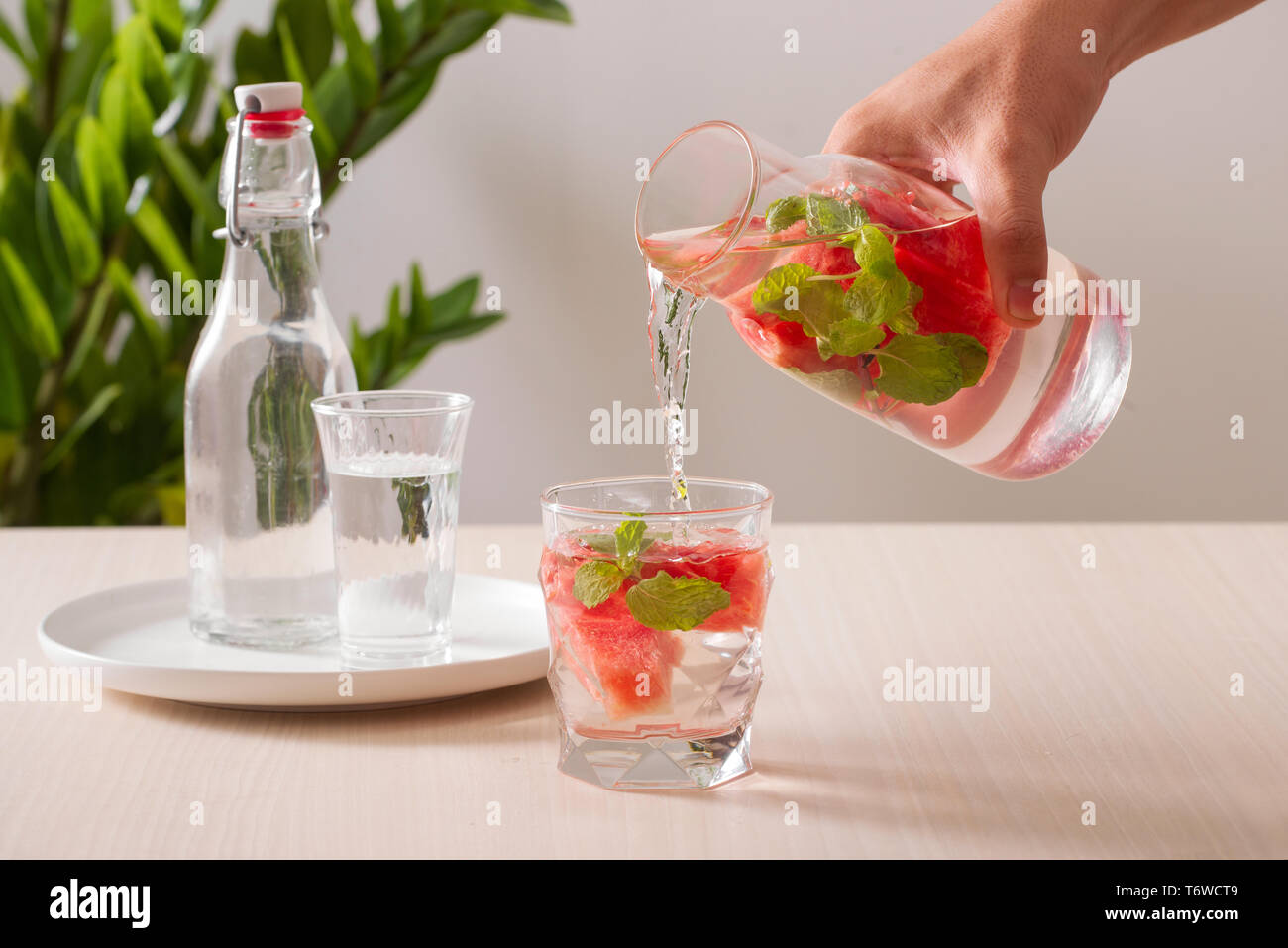 Watermelon infused water on white background Stock Photo - Alamy