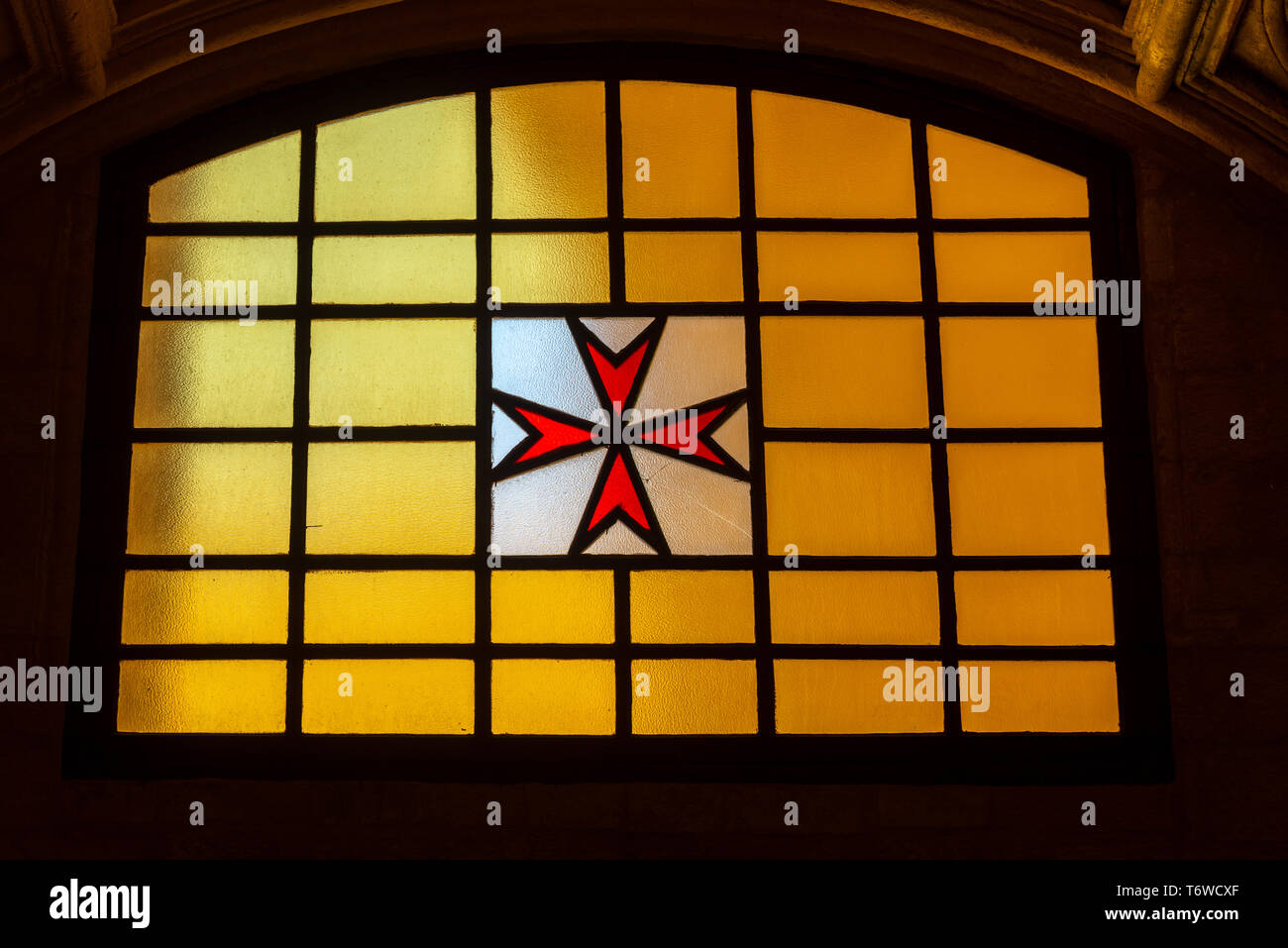 A bright red Maltese Cross in the window of The Chapel of Saint Anne in ...