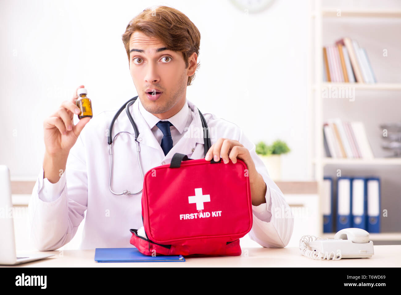 Young doctor with first aid kit in hospital Stock Photo - Alamy