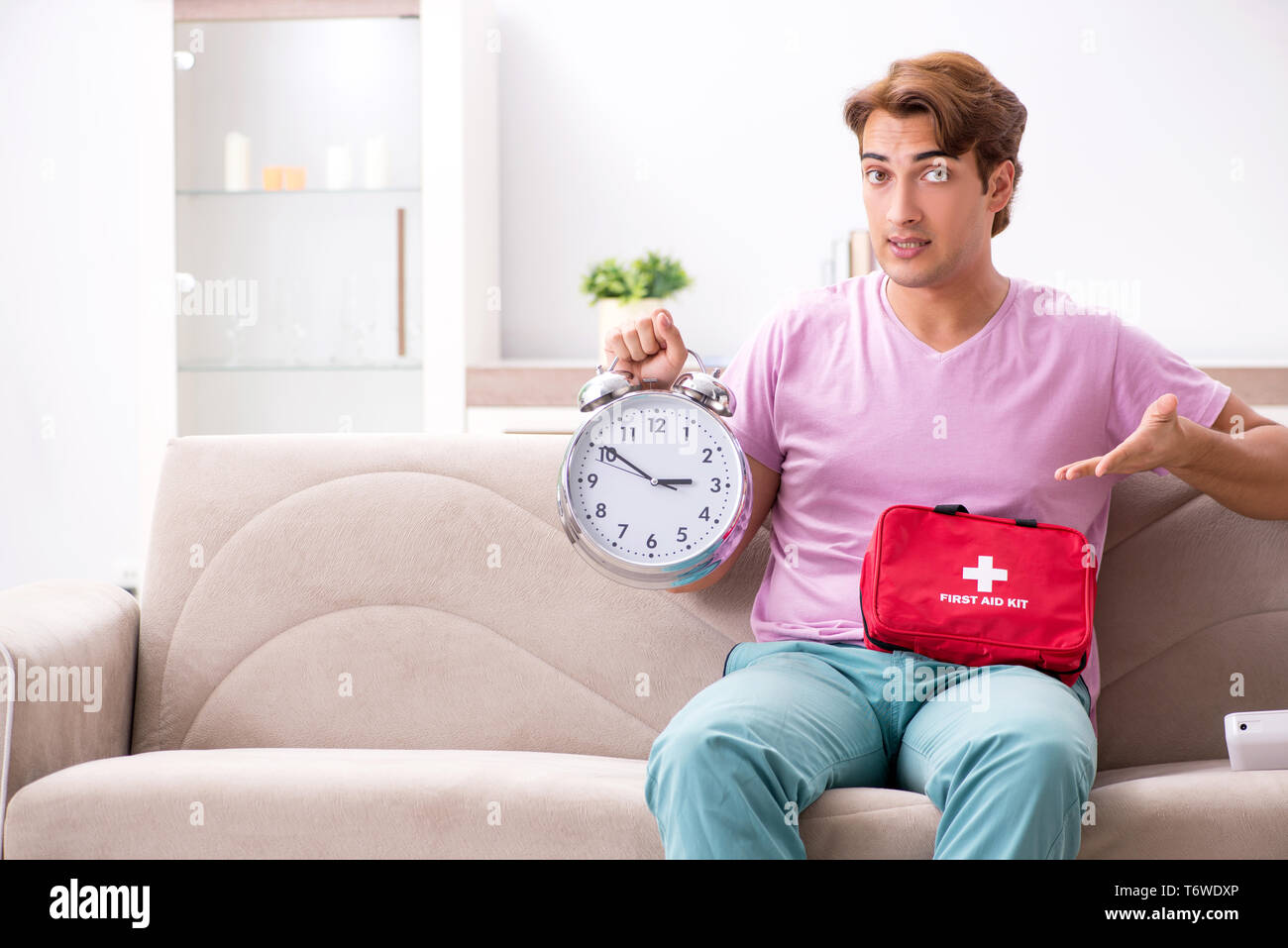 Sick man at home with first aid kit Stock Photo - Alamy