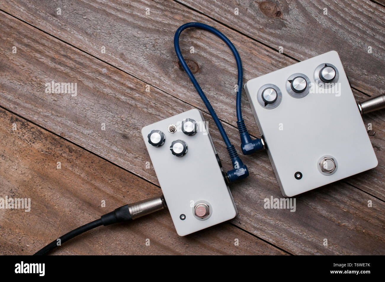 Two vintage guitar pedal effects on wood background Stock Photo - Alamy