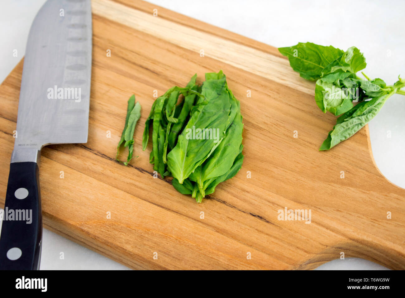 Julienned Basil Leaves on a Cutting Board Stock Photo - Alamy