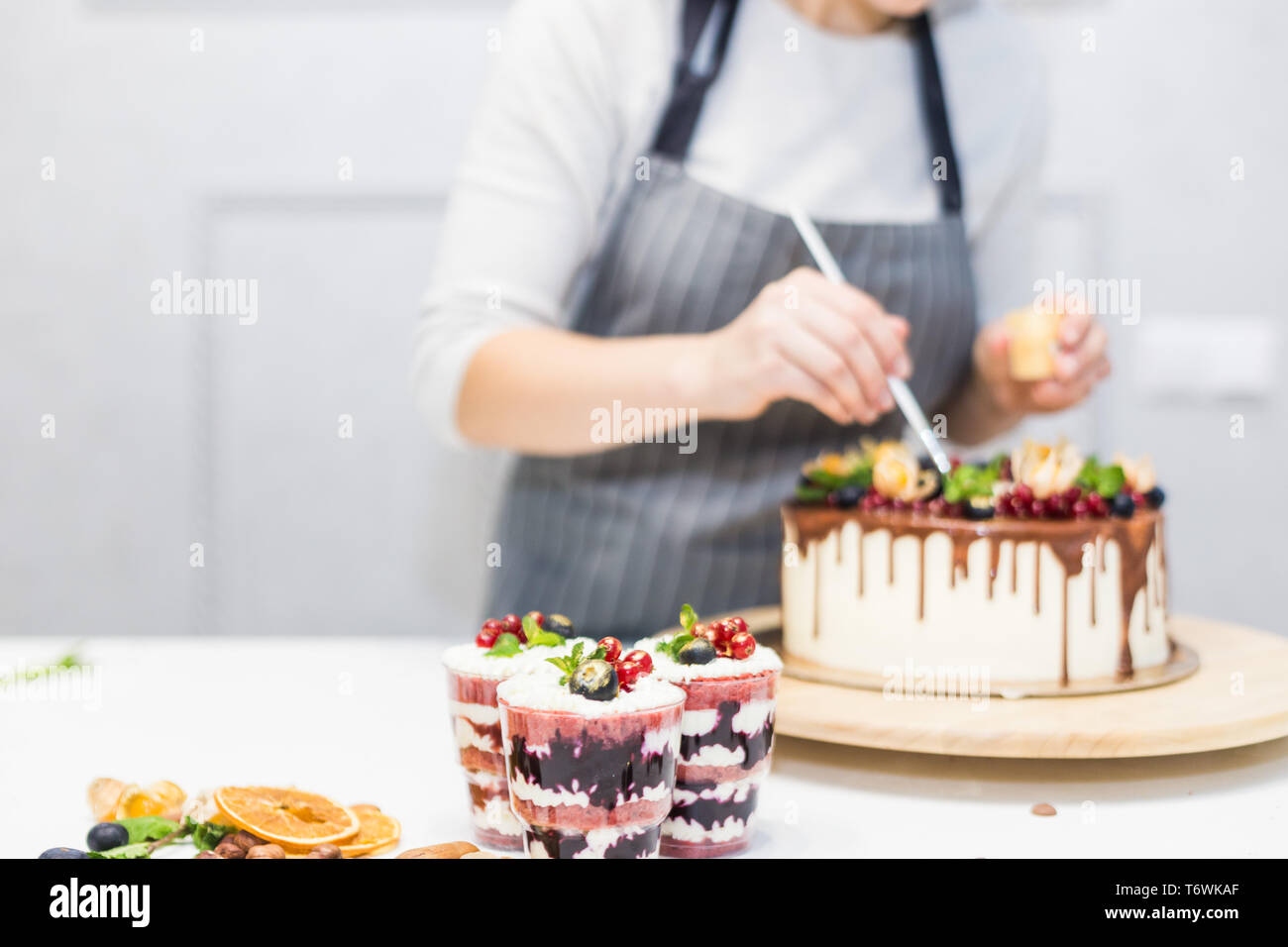 Decoration of the finished dessert. Pastry chef sprinkles confectionery ...