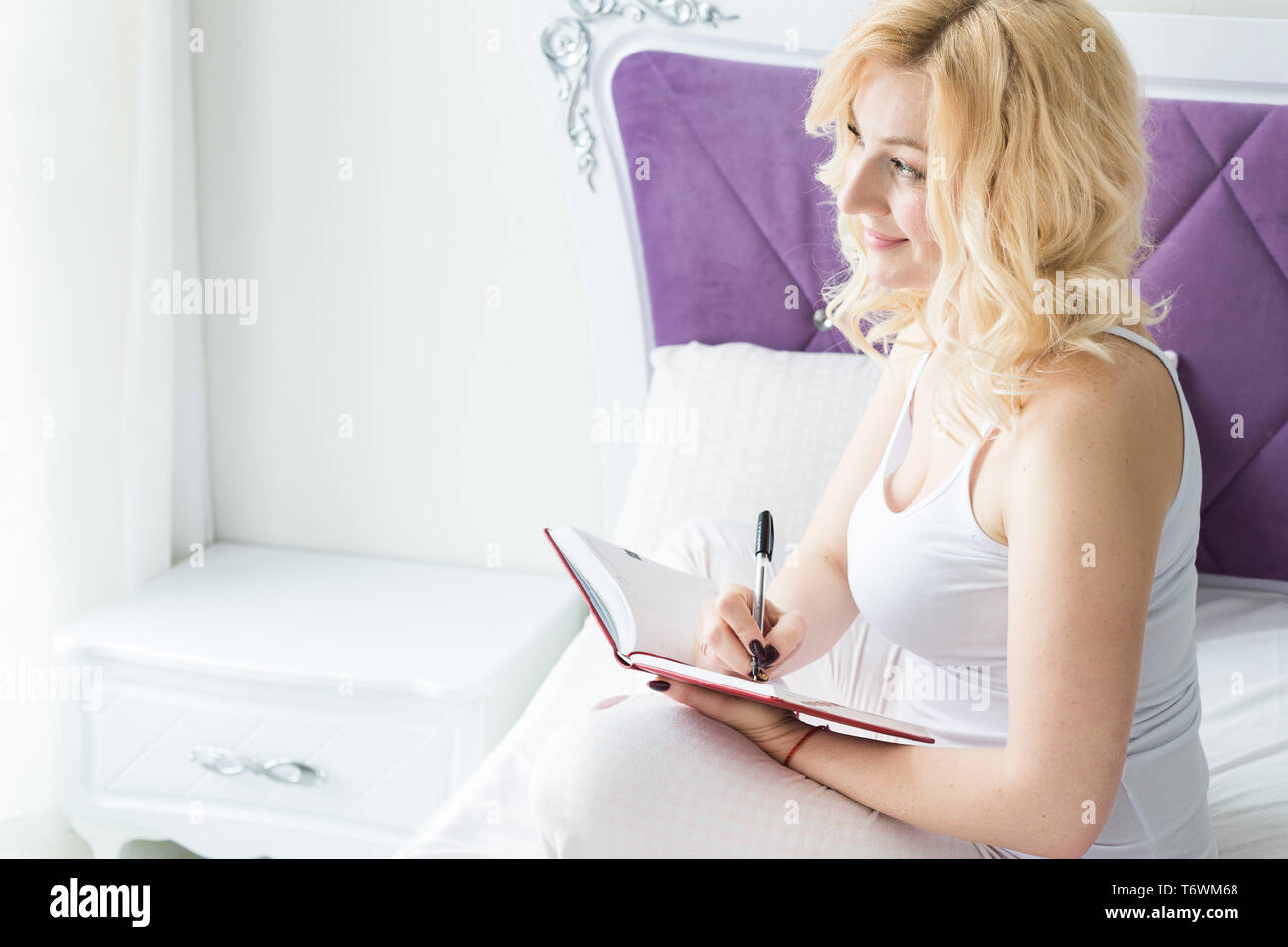 Woman lying on edge of bed hi-res stock photography and images - Alamy