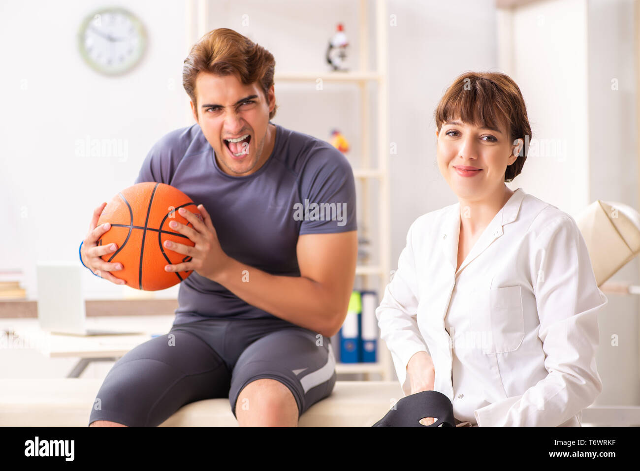 Handsome basketball player visiting female doctor traumatologist Stock ...