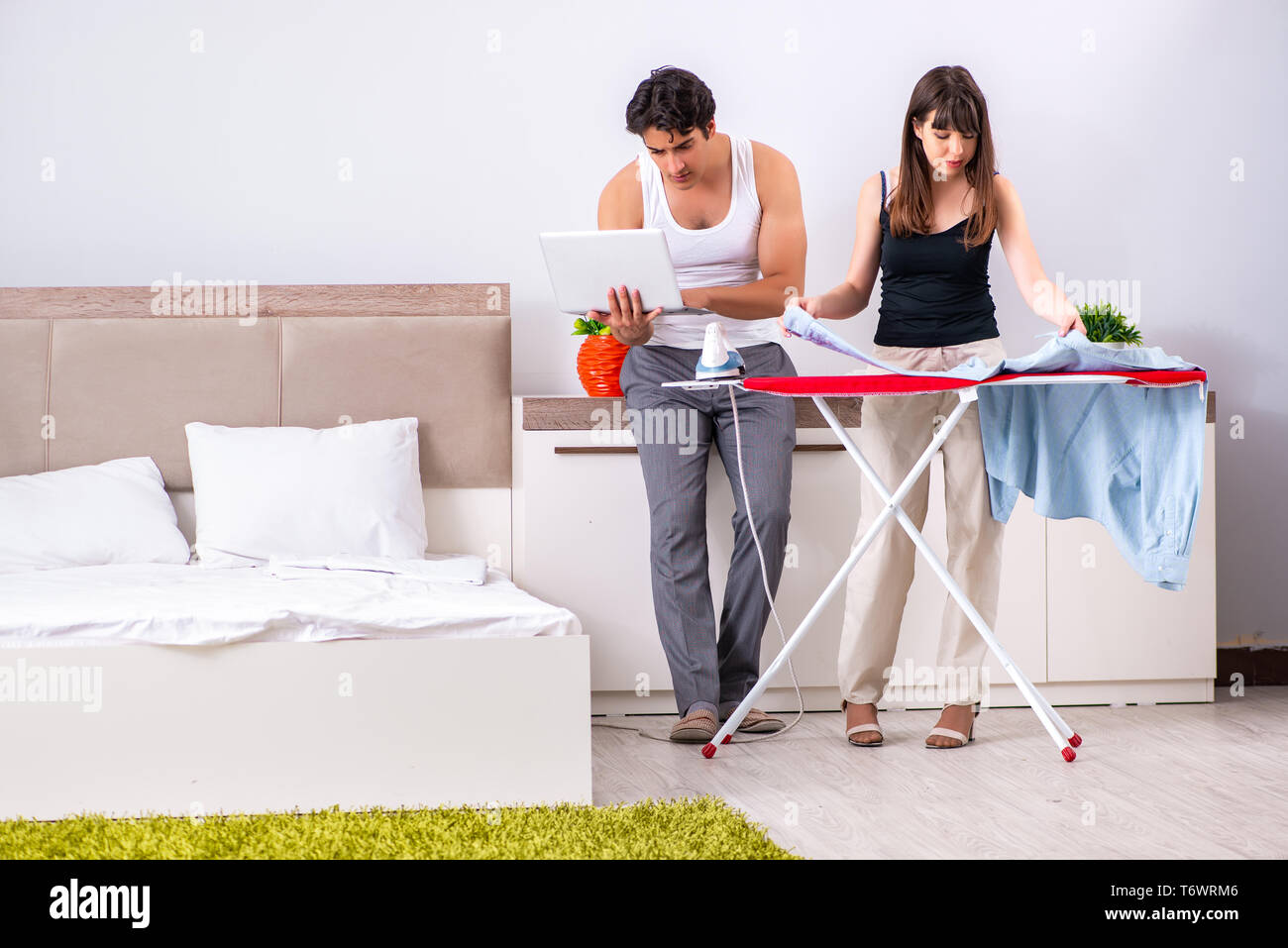 Woman ironing bed hi-res stock photography and images - Alamy