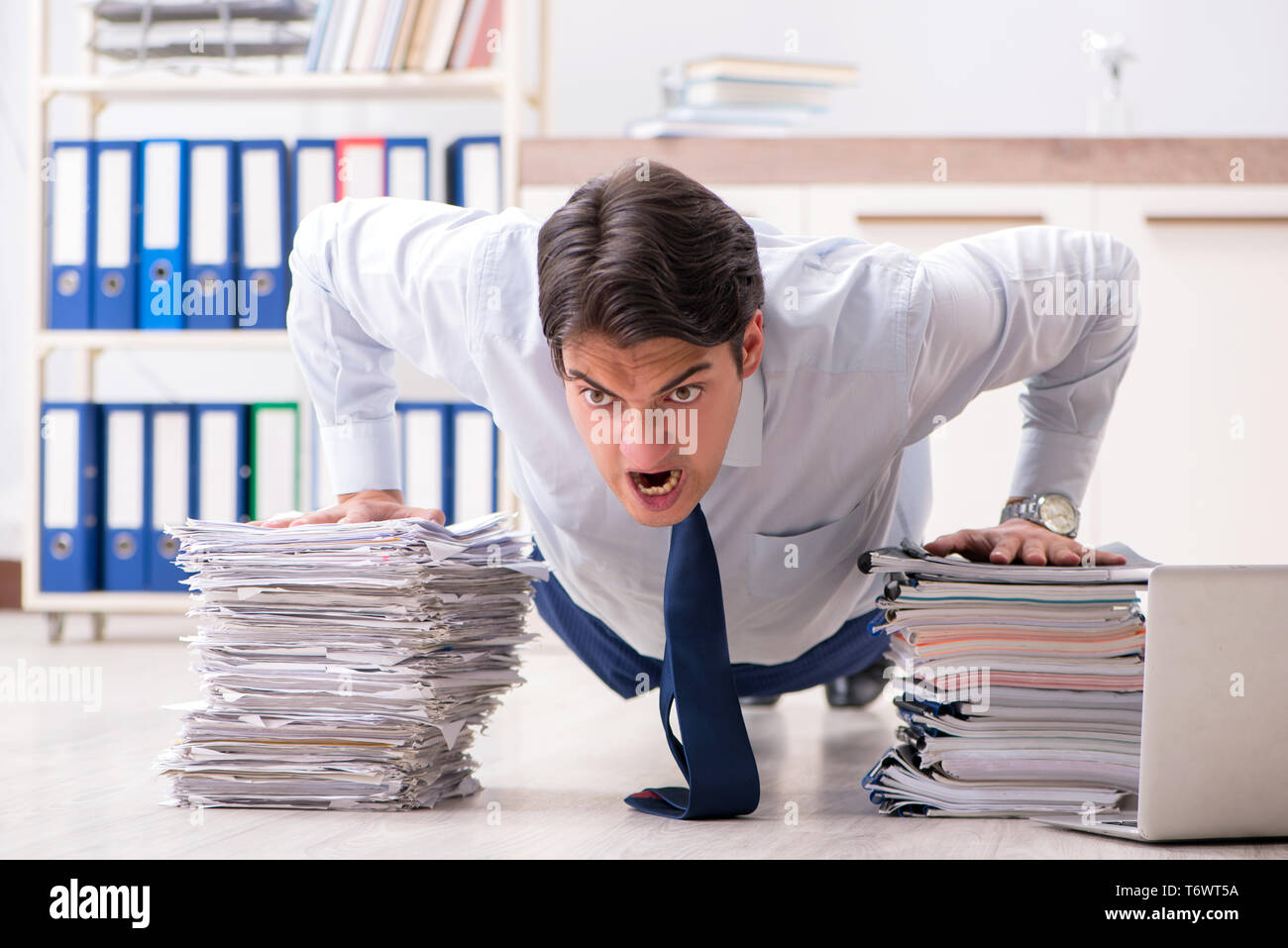 Extremely busy employee working in the office Stock Photo - Alamy