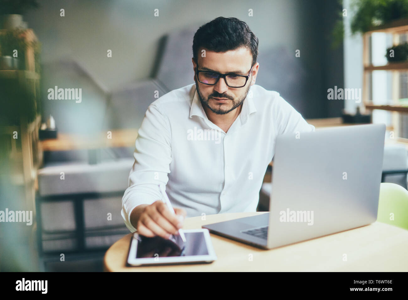 Attractive man working in cafe Stock Photo - Alamy