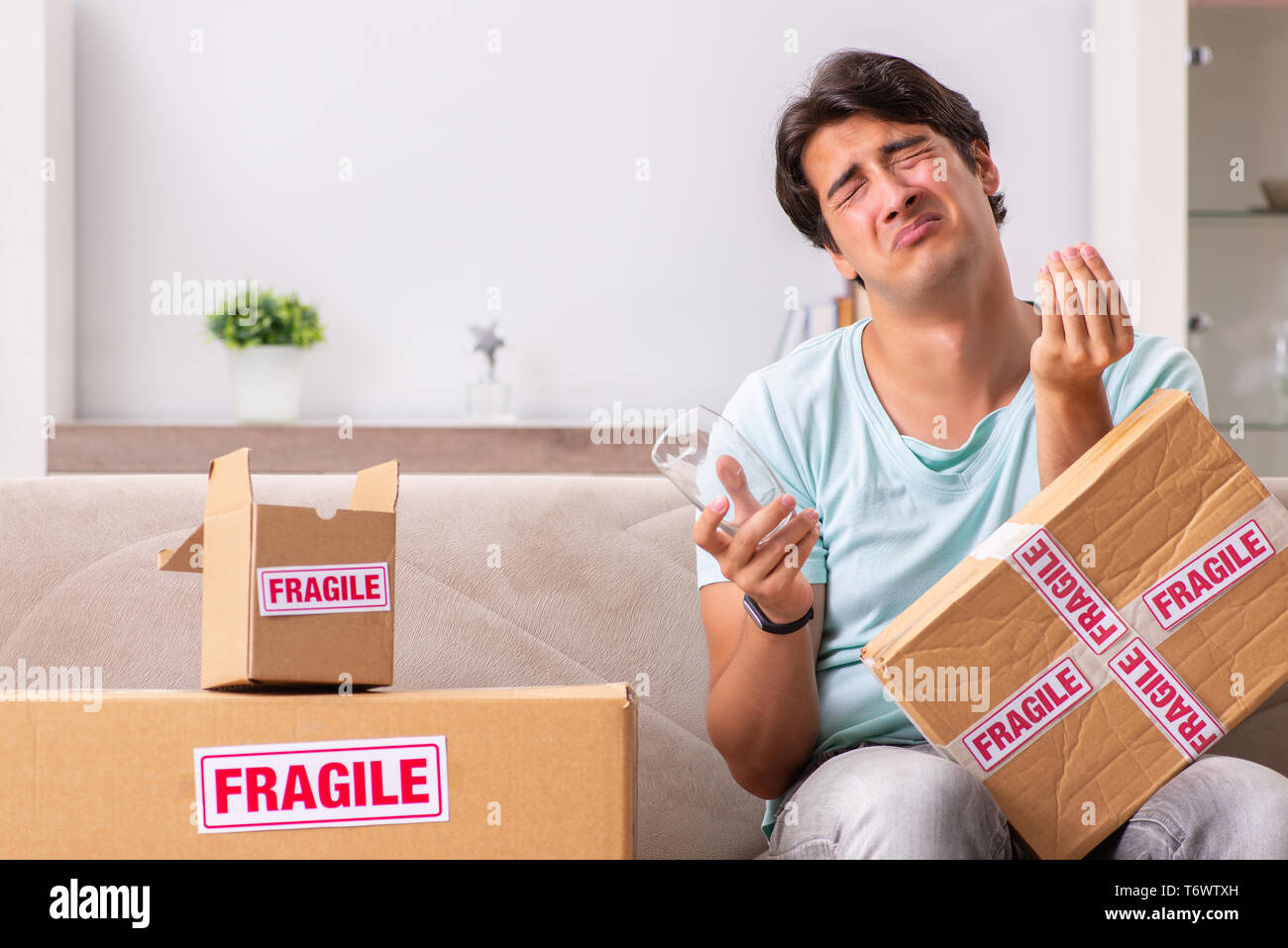 Man opening fragile parcel ordered from internet Stock Photo - Alamy