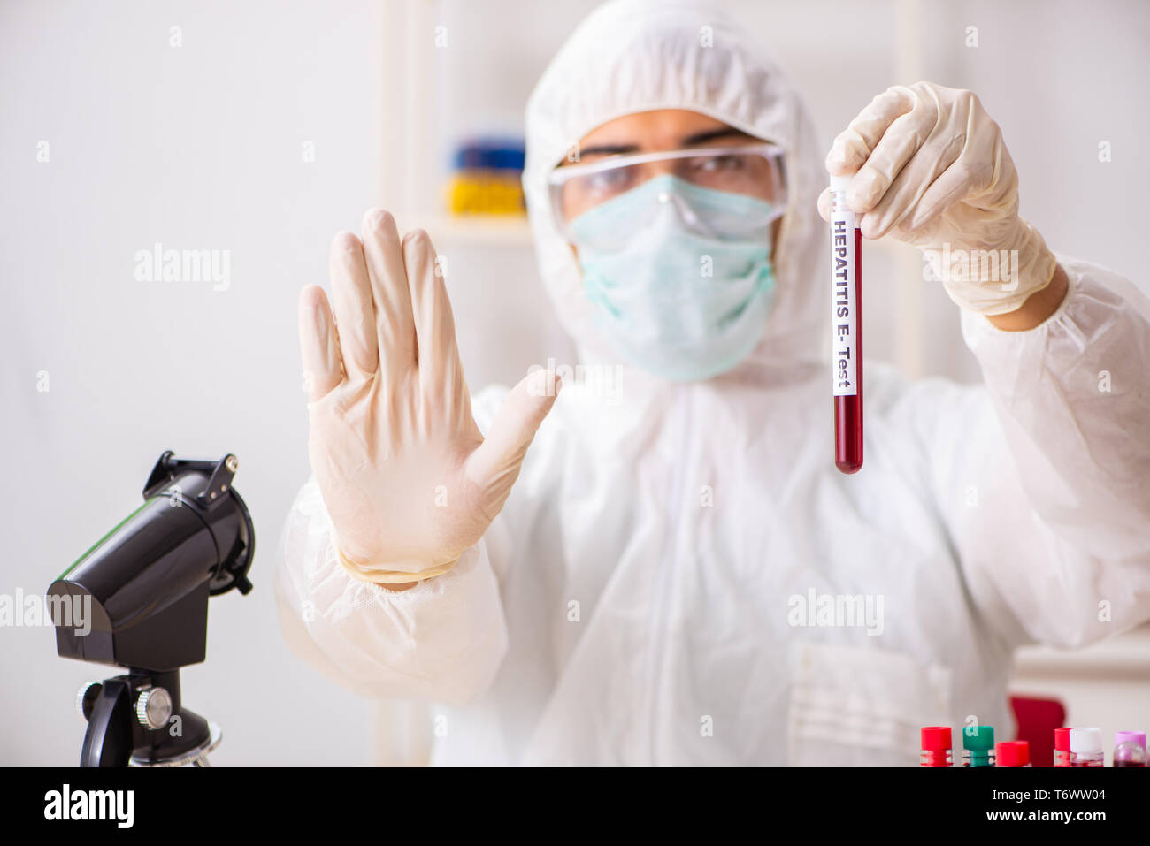 Young handsome lab assistant testing blood samples in hospital Stock ...