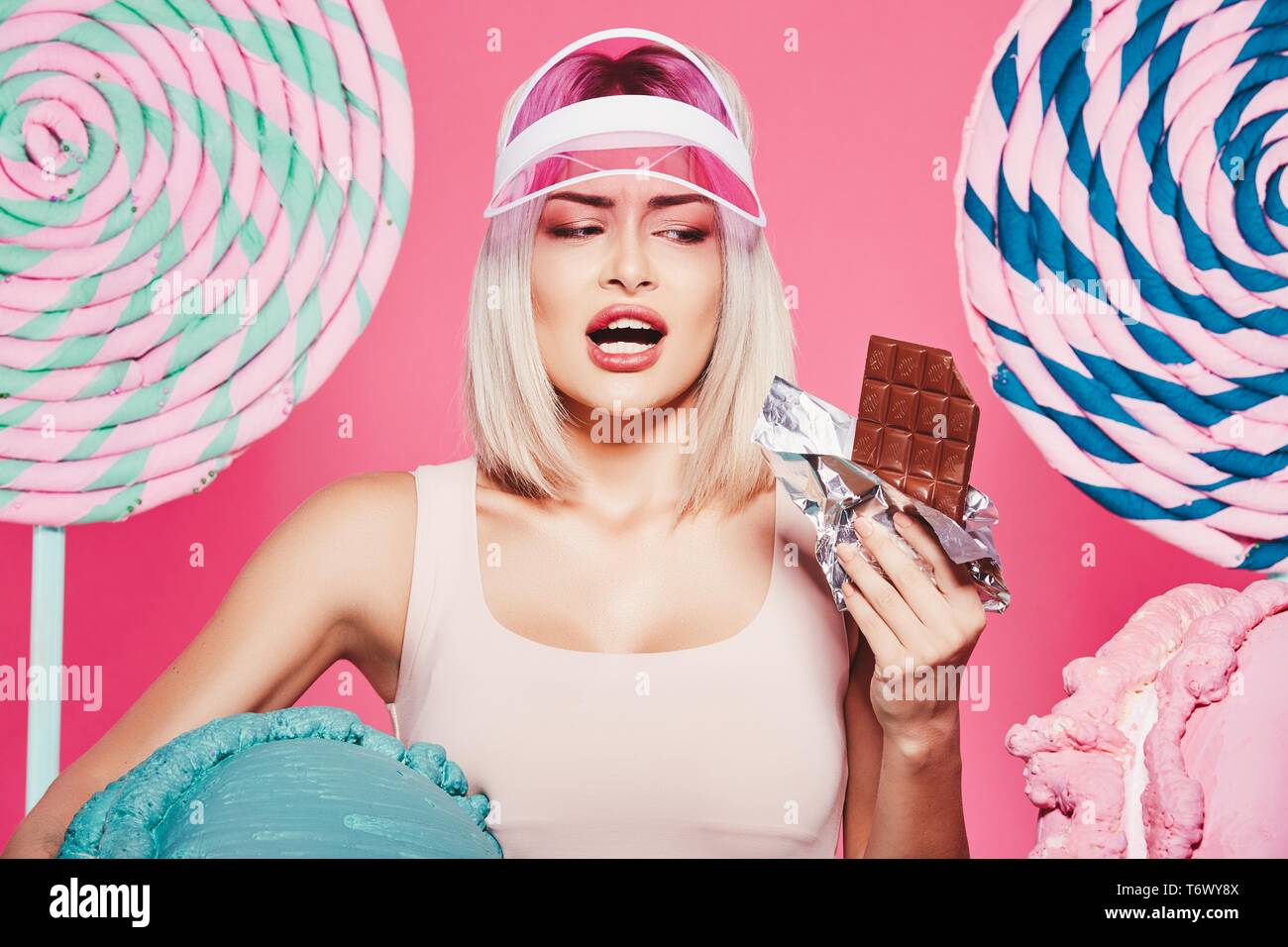 Blonde girl posing with sweets Stock Photo - Alamy