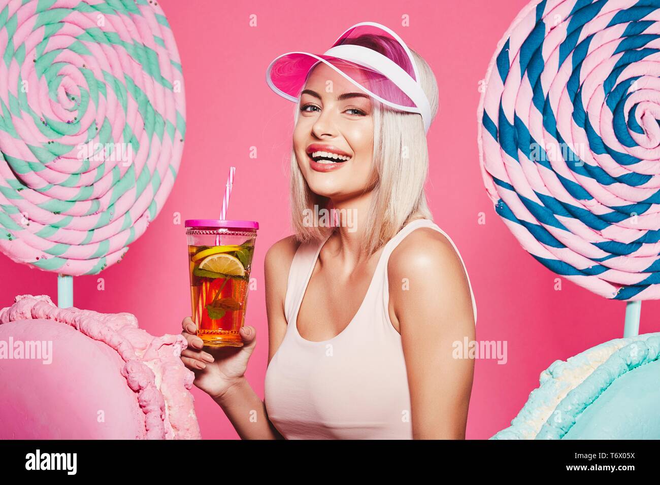 Blonde girl posing with sweets Stock Photo - Alamy