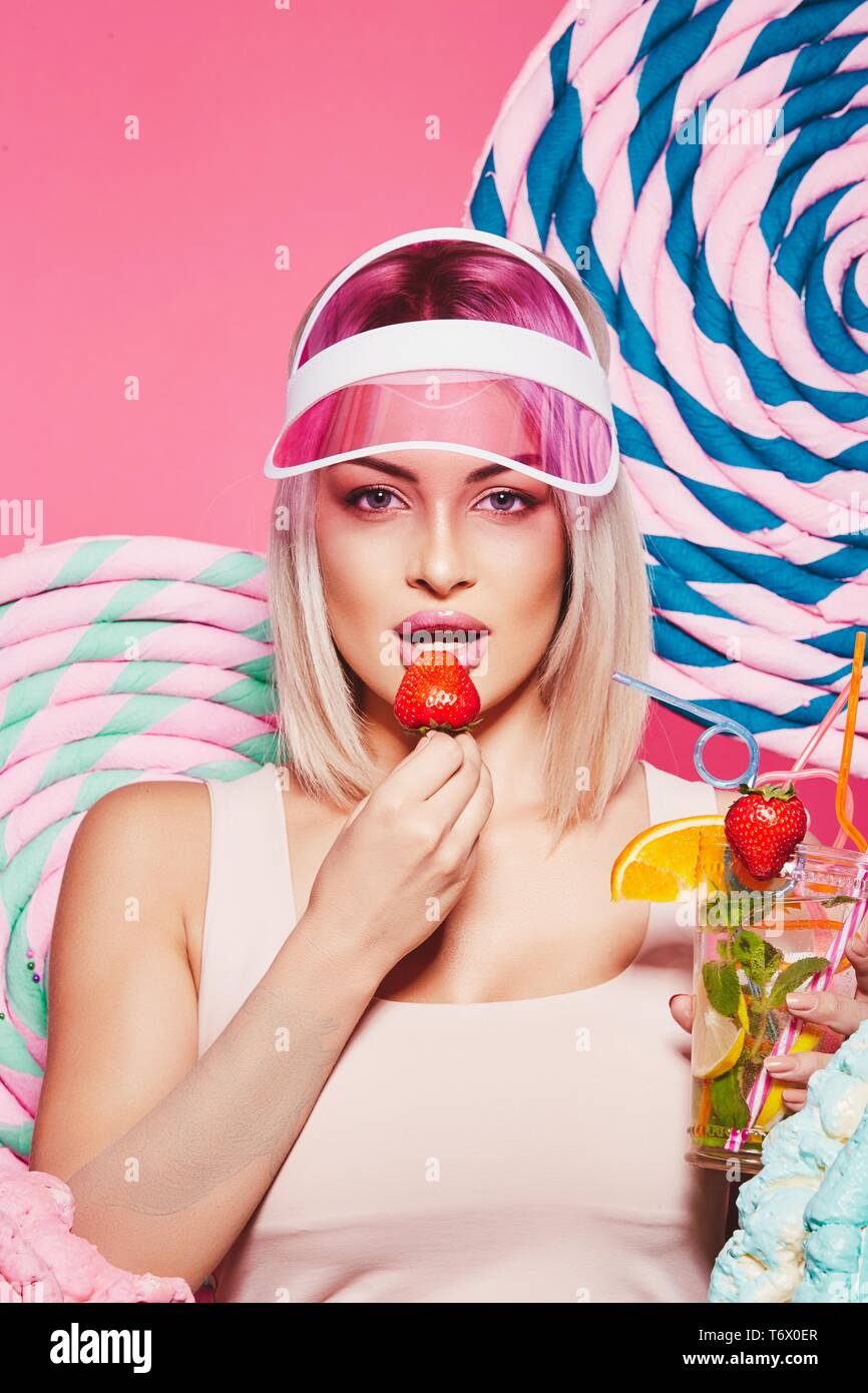 Beautiful girl drinking lemonade at pink background Stock Photo - Alamy