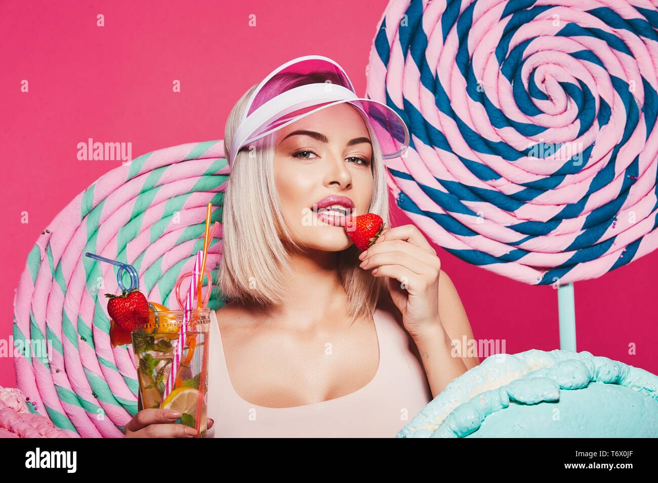 Beautiful girl drinking lemonade at pink background Stock Photo - Alamy