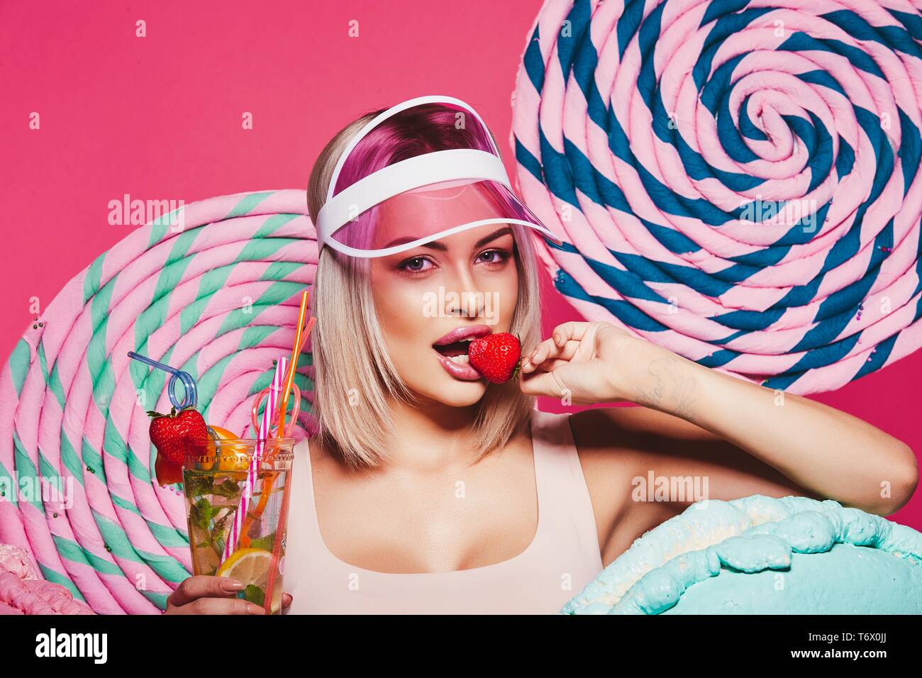 Beautiful girl drinking lemonade at pink background Stock Photo - Alamy