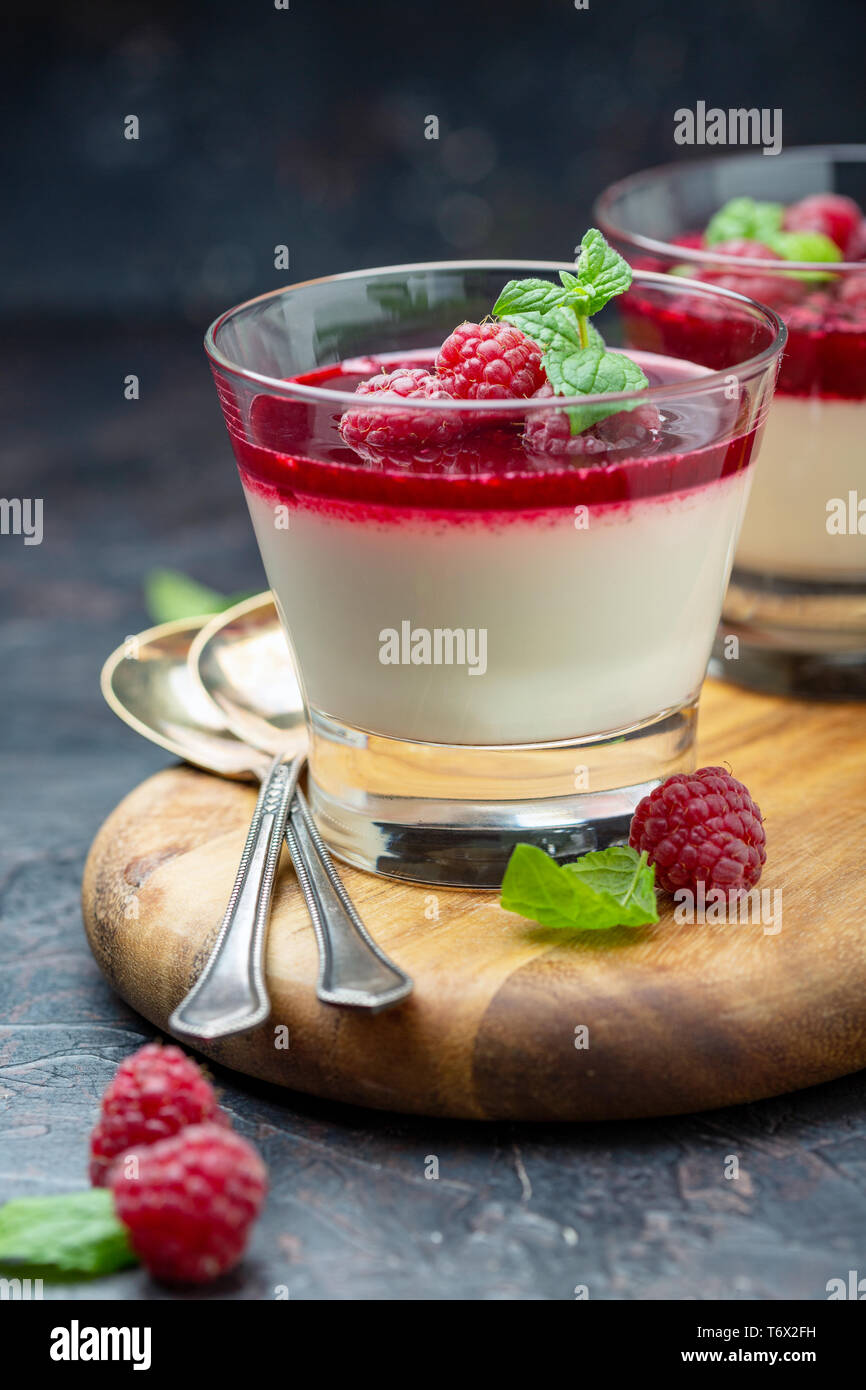 Vanilla Panna cotta with berry sauce and raspberry Stock Photo - Alamy