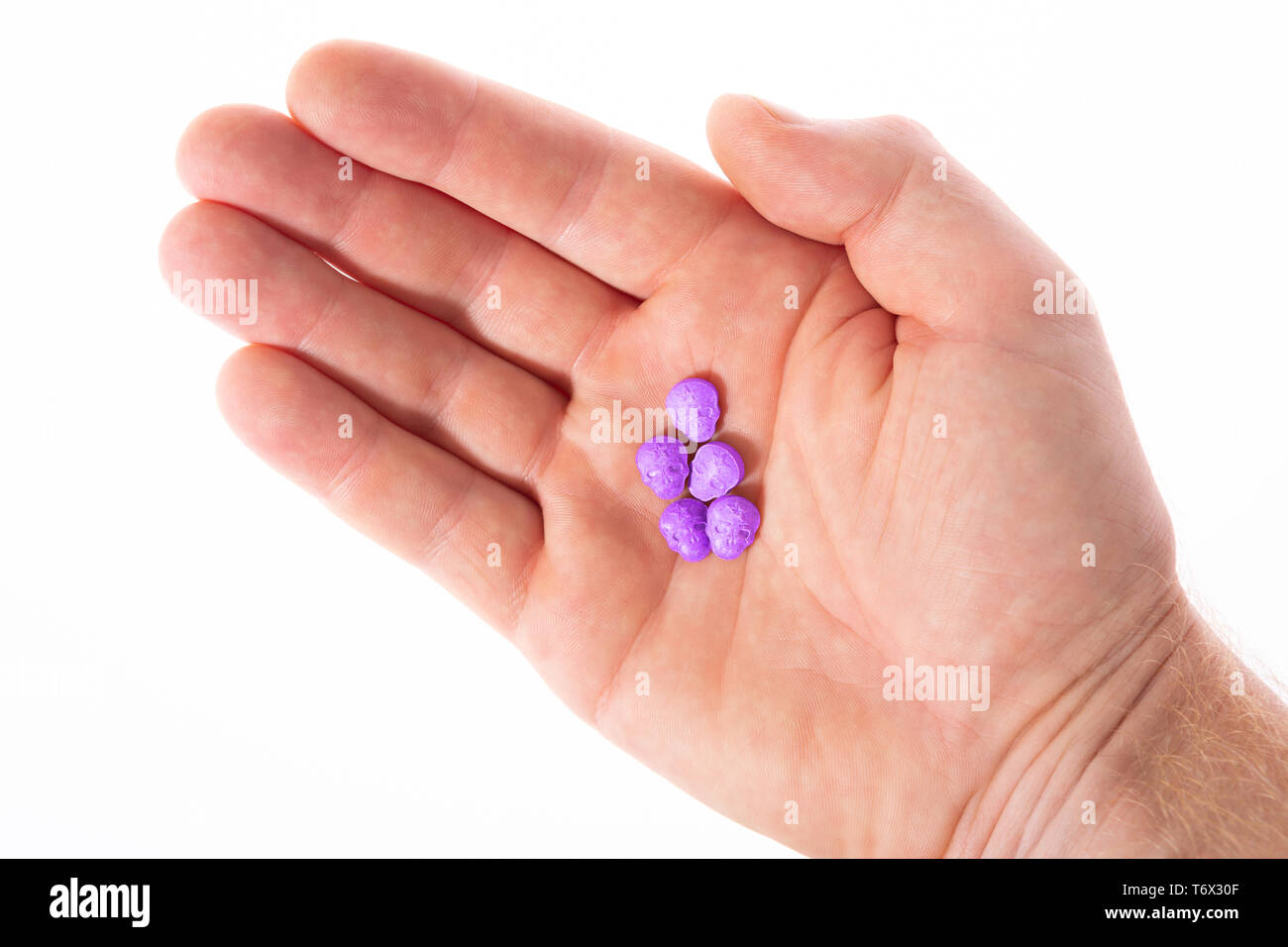 Topview of the palm of caucasian hand with a little pile of purple Army ...