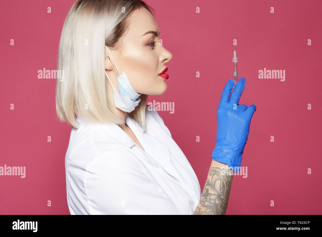 Female doctor at pink studio background Stock Photo - Alamy