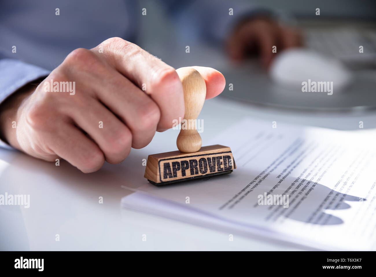 Close-up Of A Person's Hand Stamping With Approved Stamp On Document At ...
