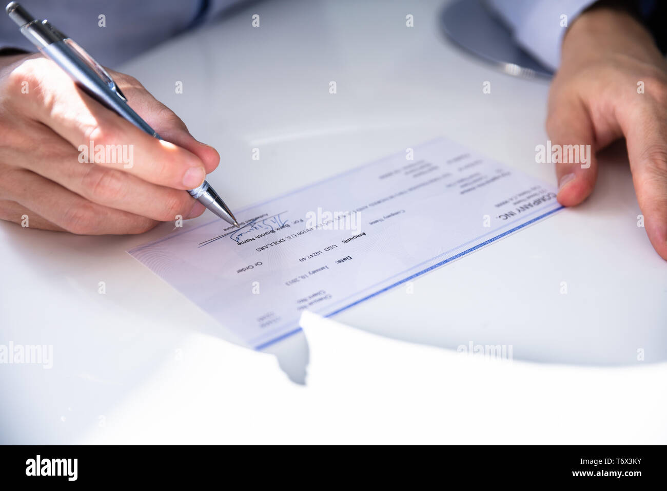 Signing cheques hi-res stock photography and images - Alamy