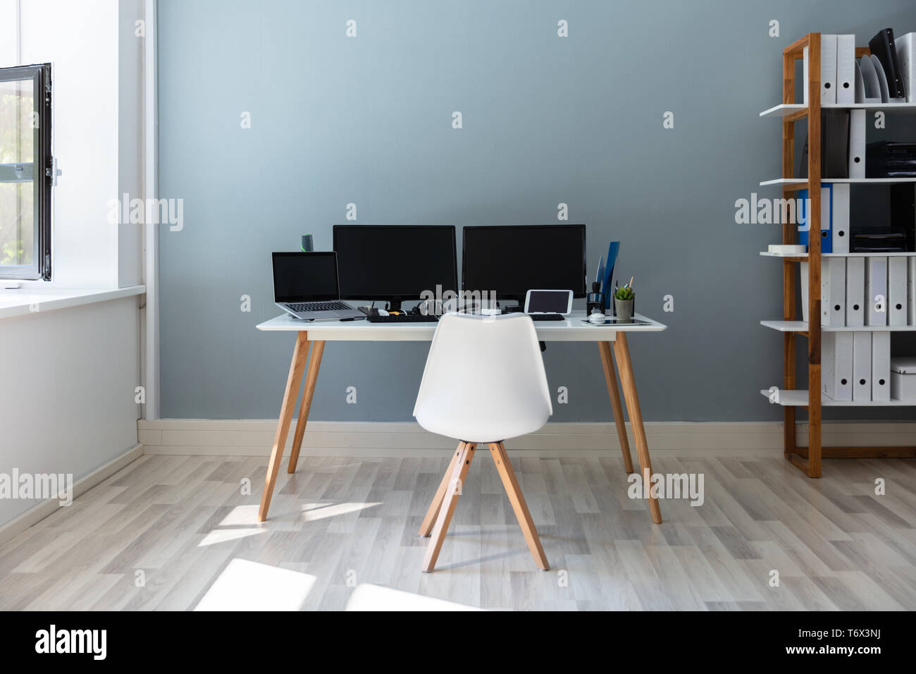 Computer On Desk In Modern Interior Office Stock Photo - Alamy