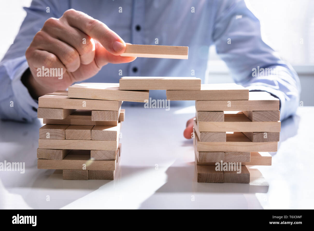 Conceptual Photo Of Businessman Building Bridge To Connect Two Towers ...