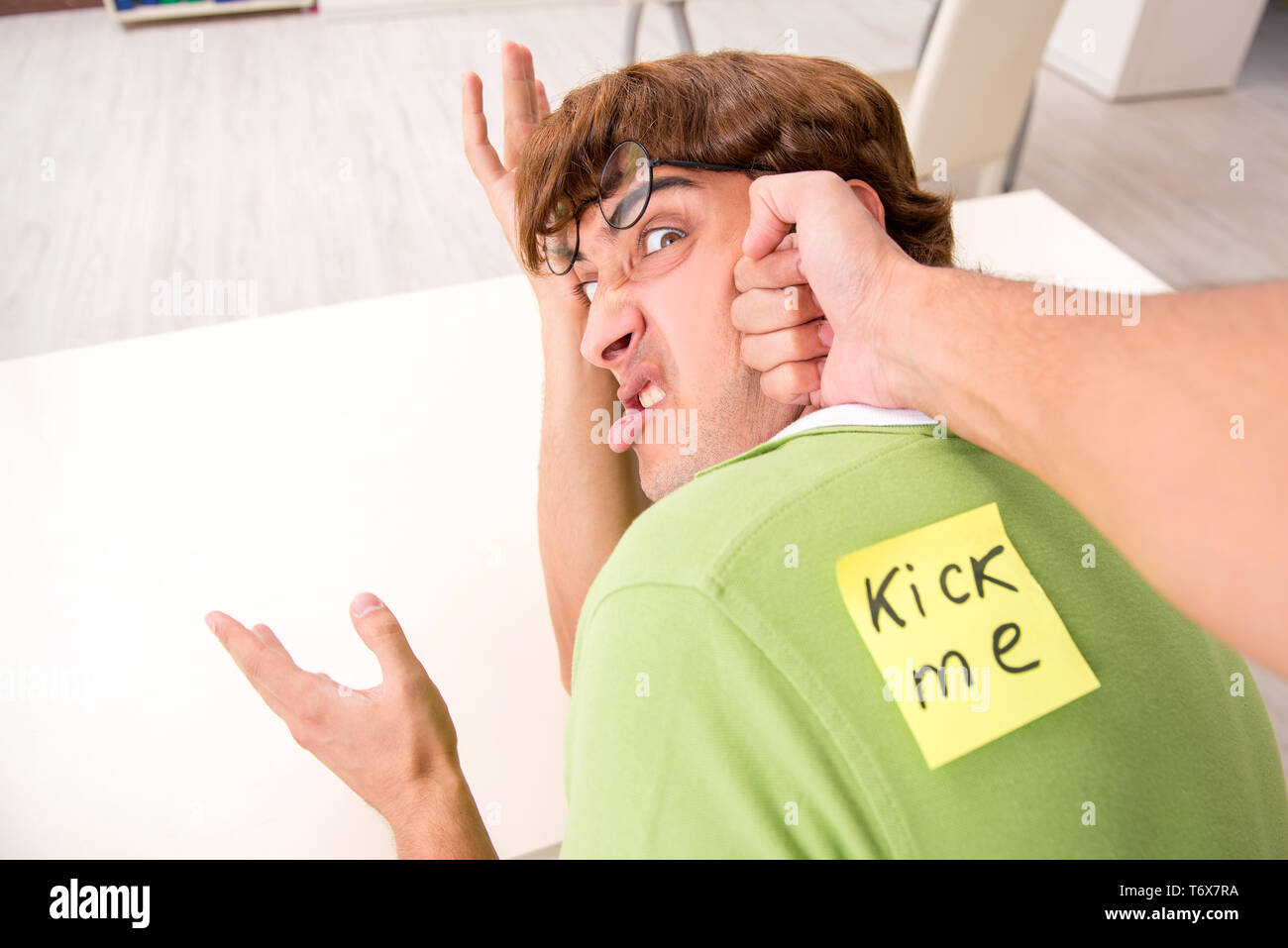 Office prank with kick me message on sticky note Stock Photo - Alamy