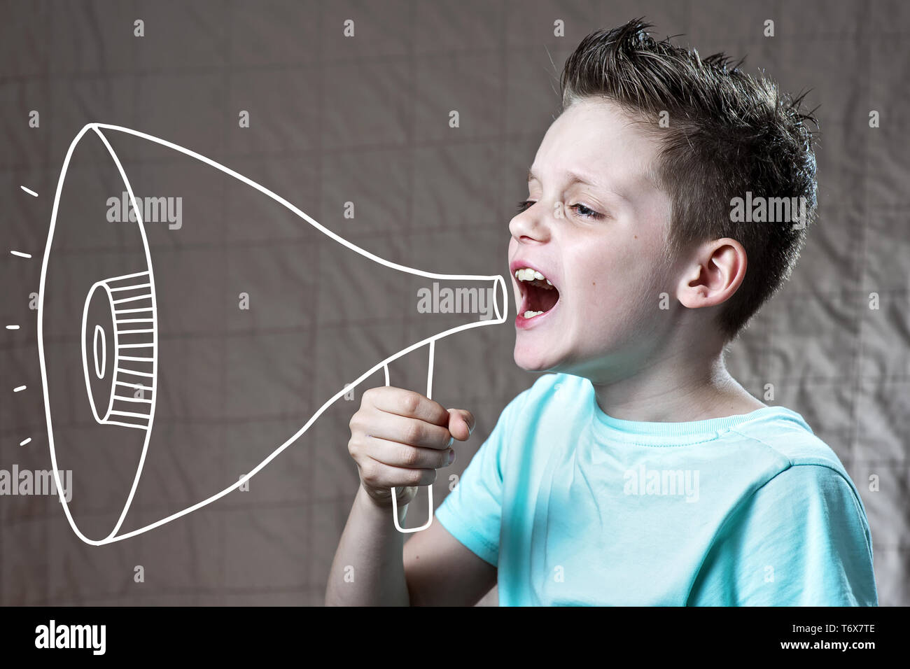 a boy painted with a loudspeaker shouting at him Stock Photo - Alamy