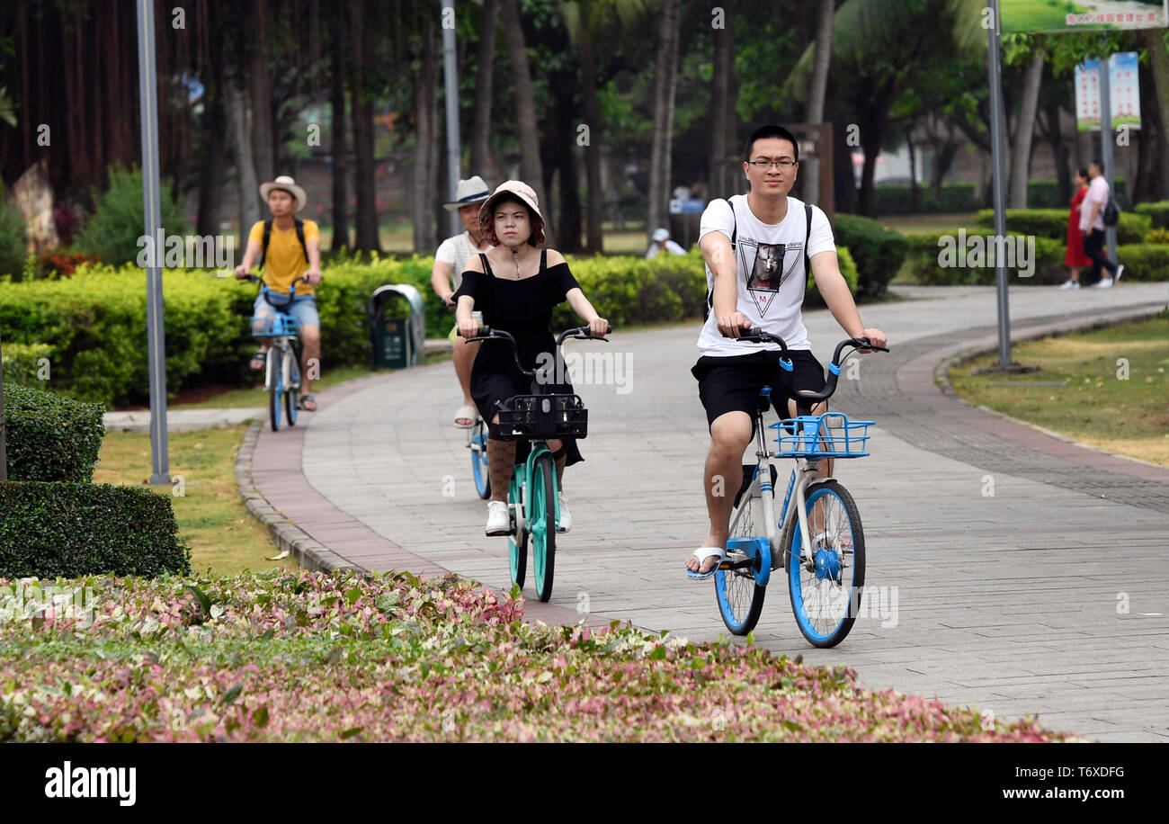 Haikou, China's Hainan Province. 3rd May, 2019. People ride bike at a ...