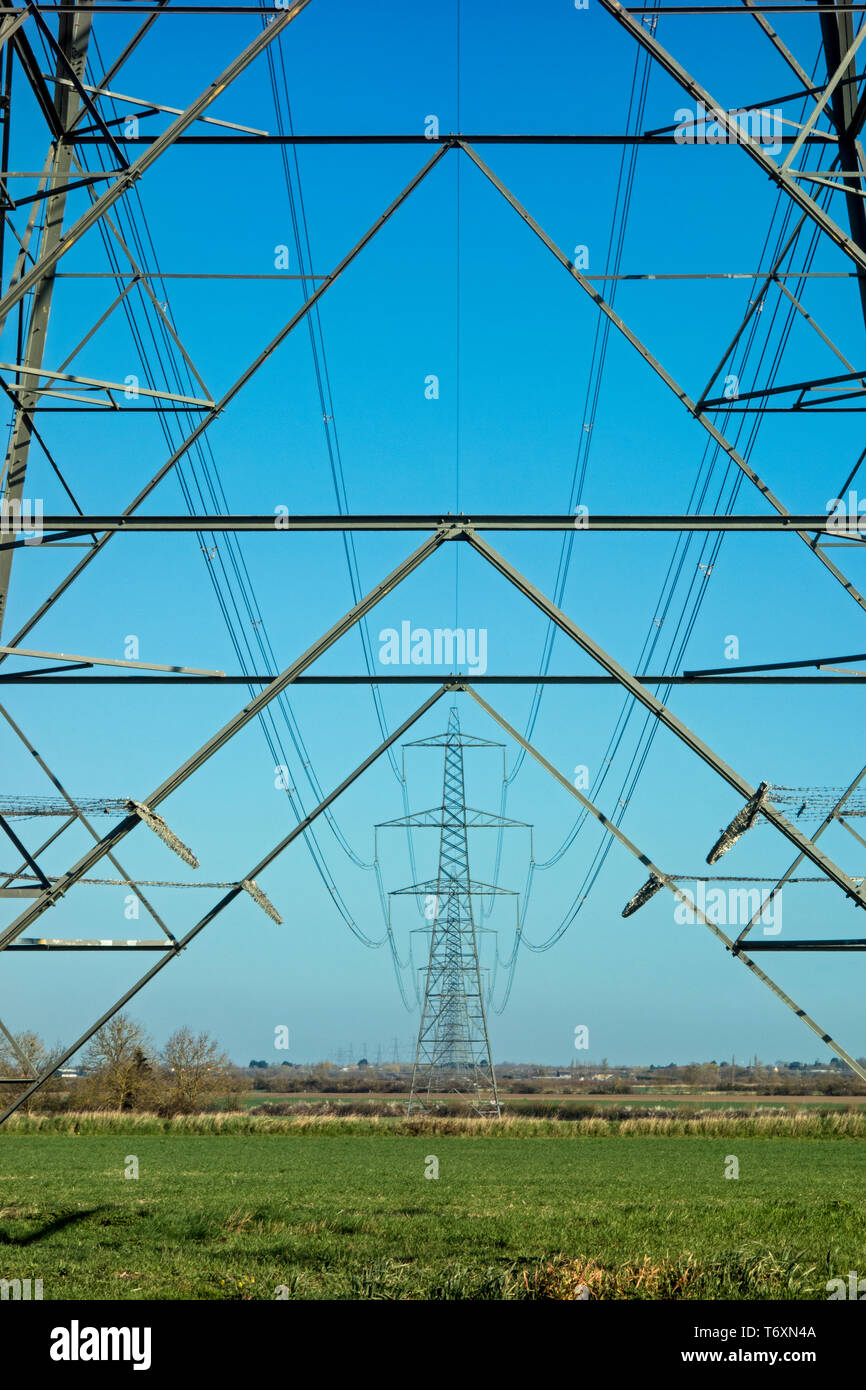 Line of electricity pylons with blue sky, Cambridgeshire, England, UK ...