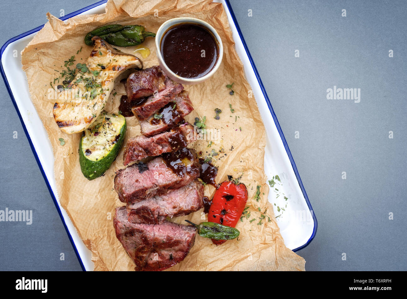 Traditional German barbecue sliced rostbraten with fried mushrooms and ...