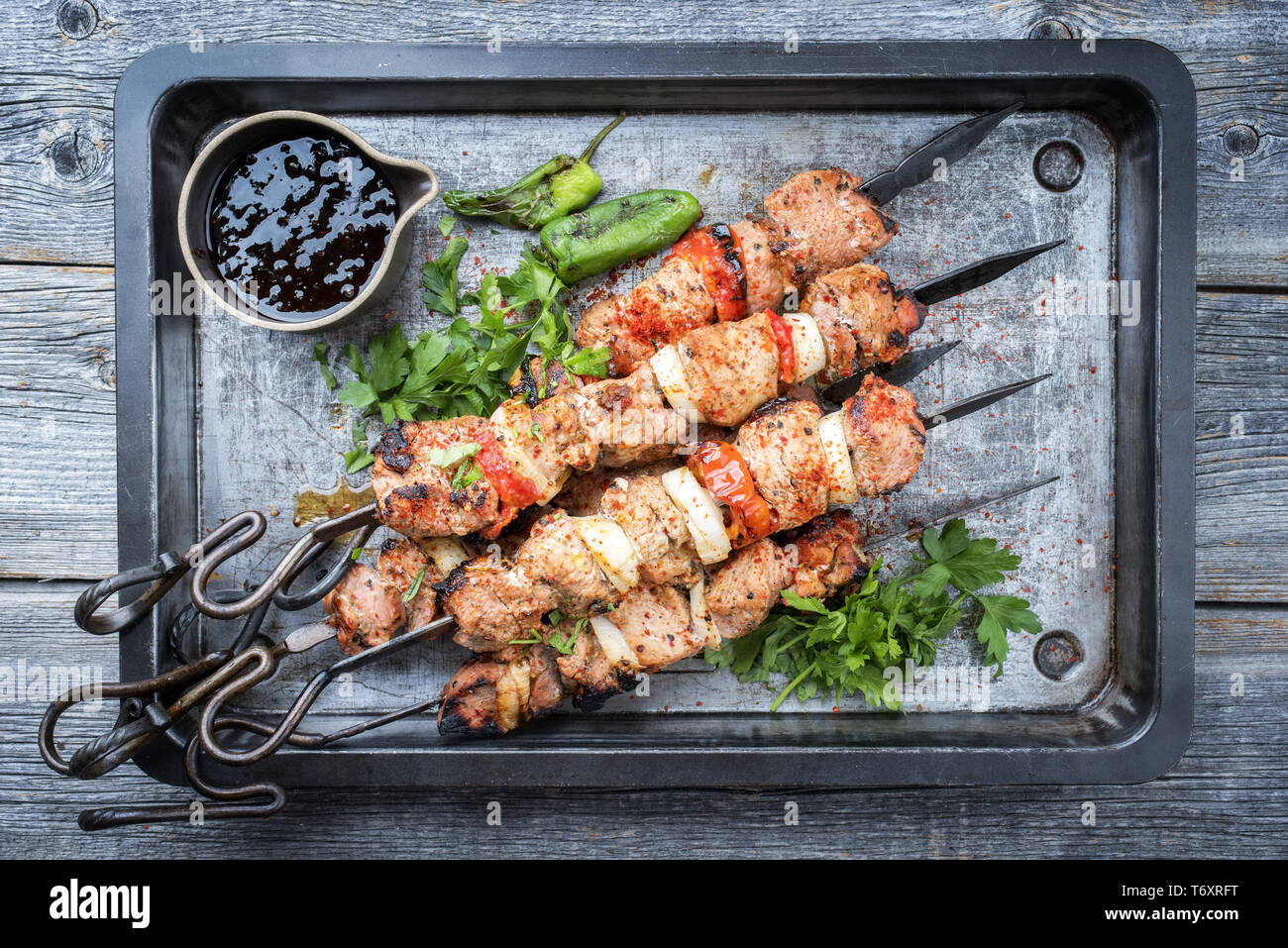 Traditional Greek souvlaki barbecue skewer with tomato Stock Photo - Alamy
